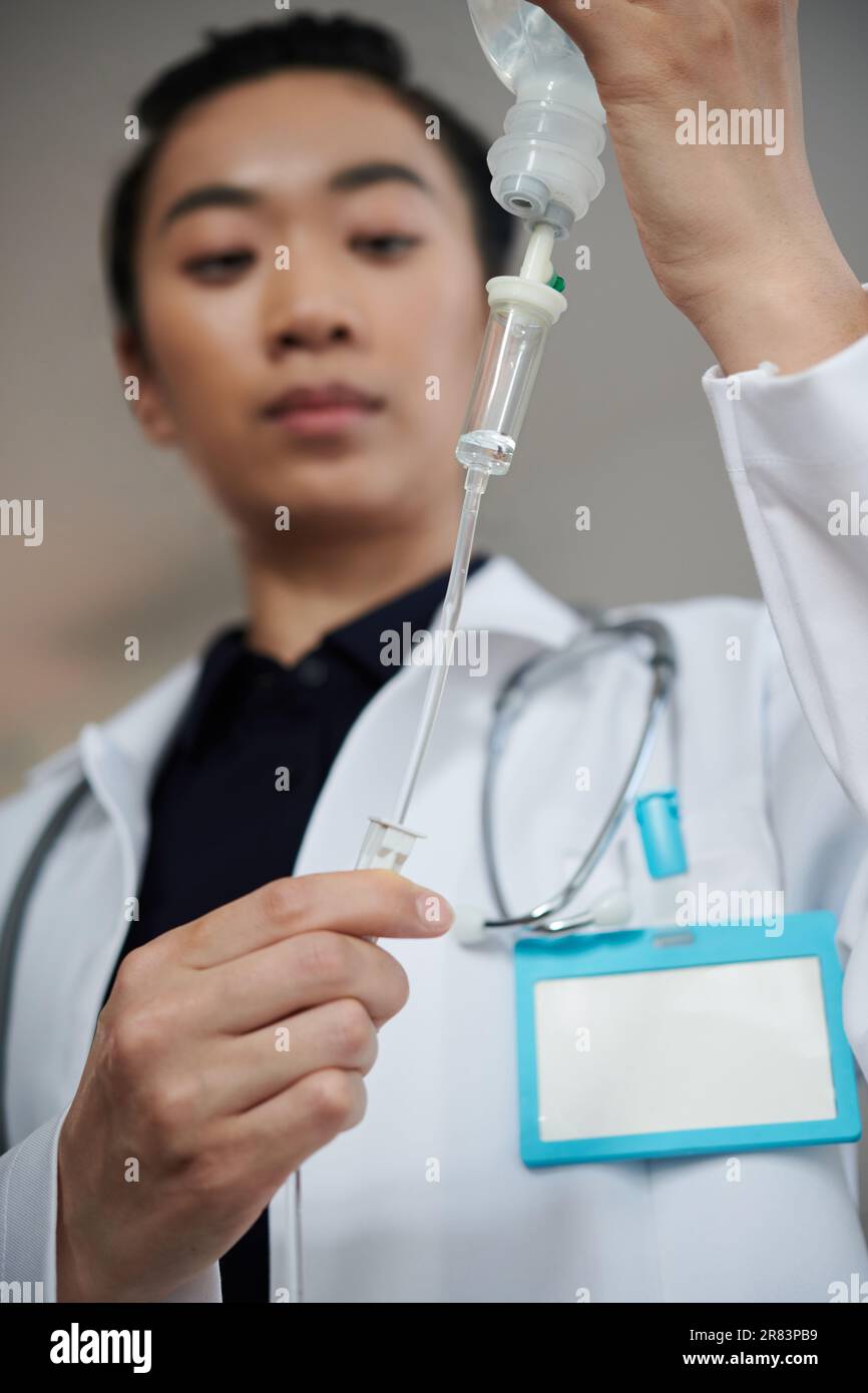 General practitioner preparing drop counter for procedure in clinic ...