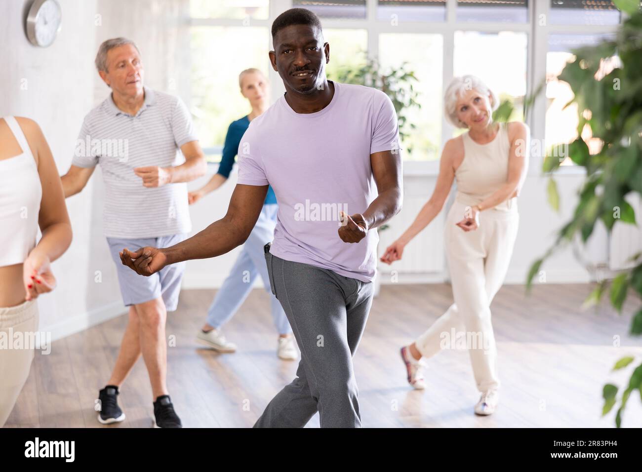 Group of multiethnic mature people dancing modern dance Stock Photo - Alamy