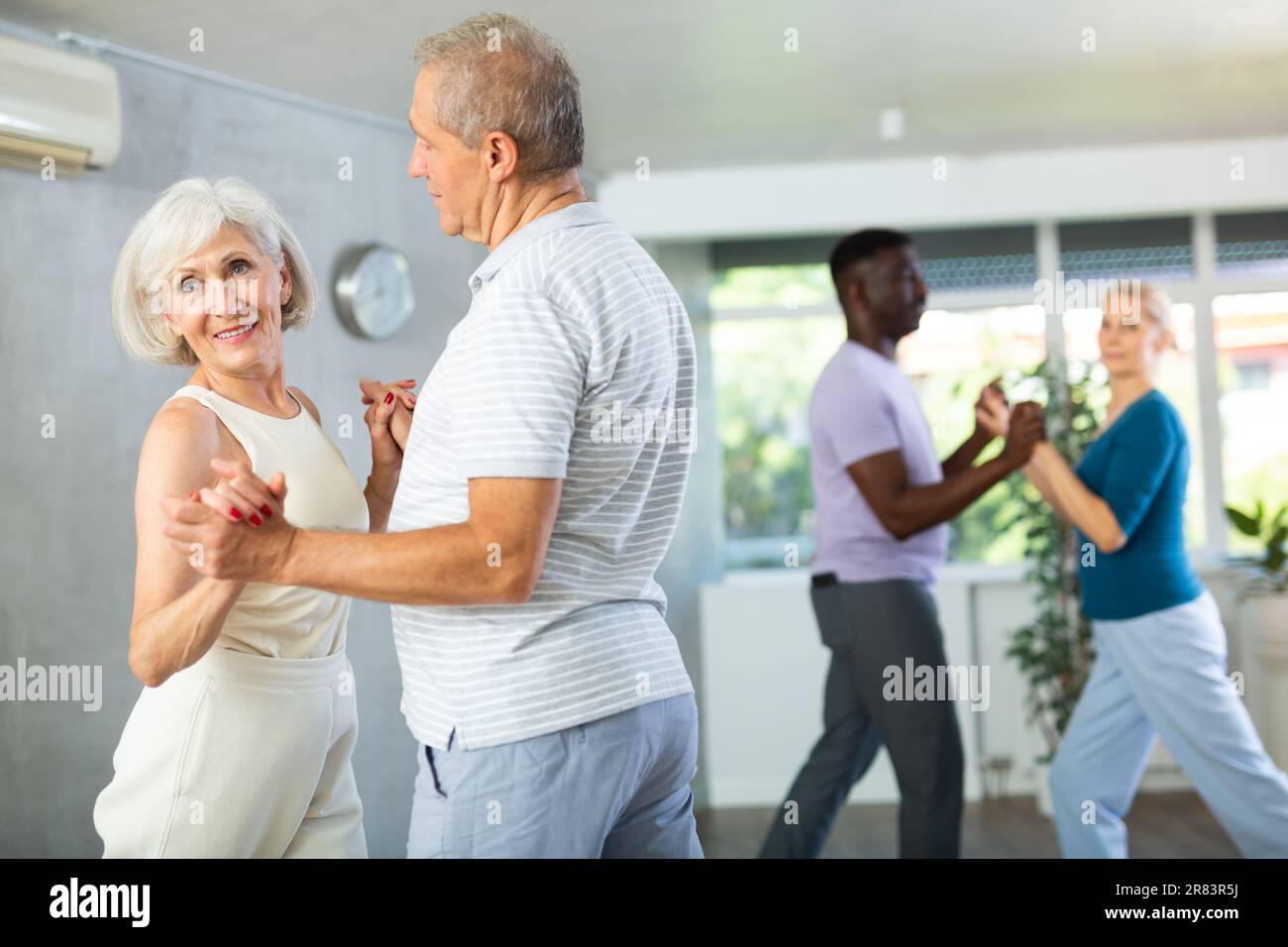 Group of multiethnic mature people dancing social dance Stock Photo - Alamy