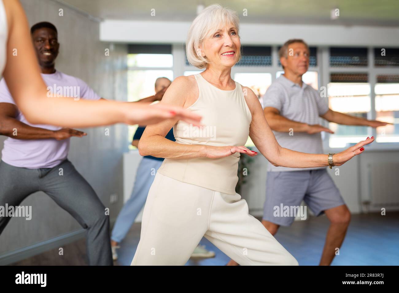 Elderly woman dancing hip hop during group dance class Stock Photo - Alamy