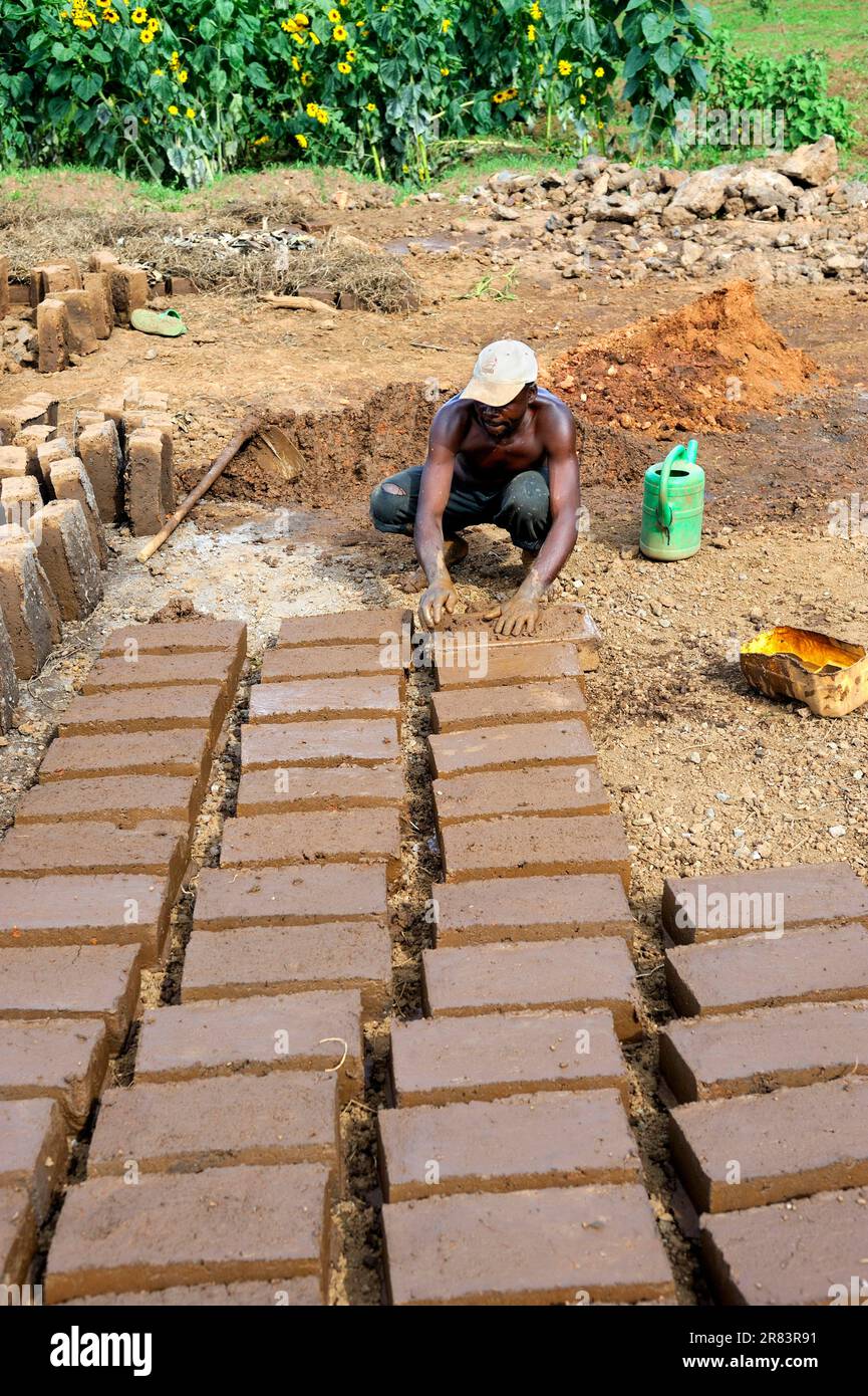 Man making mud bricks to build a house, Rwanda Stock Photo - Alamy