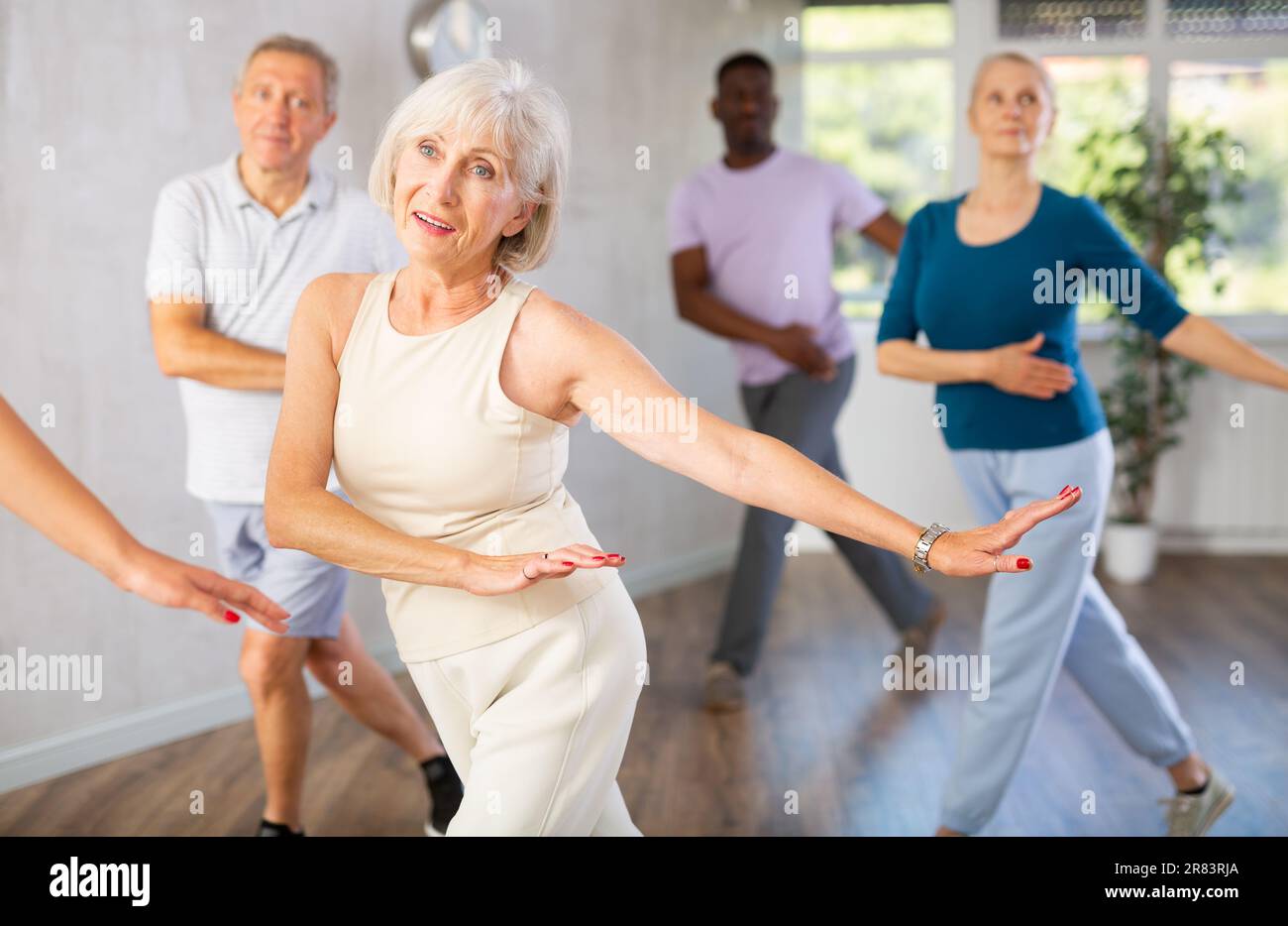 Senior woman dancing hip hop in studio practicing dance number Stock ...
