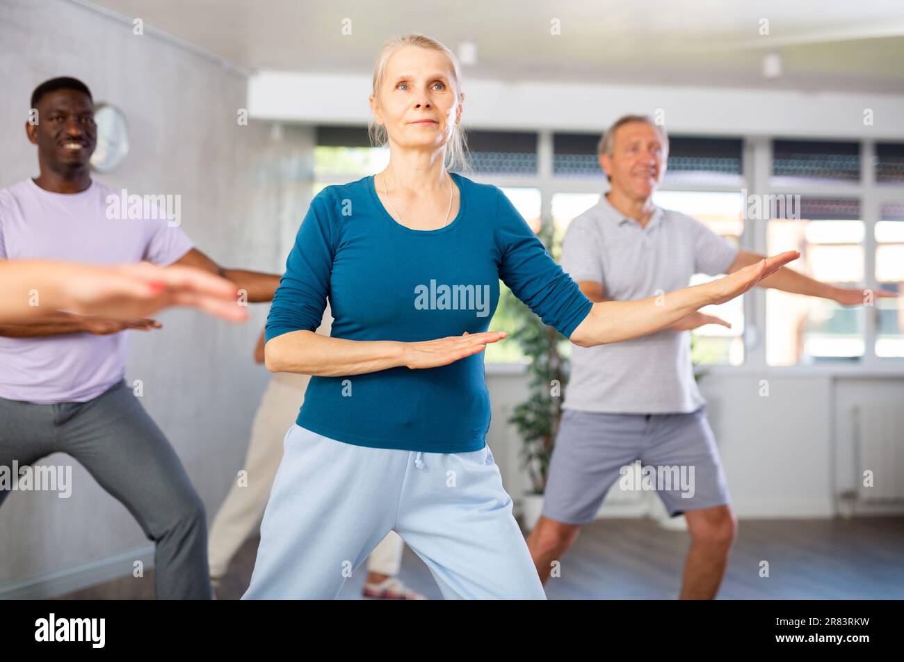 Mature men and women practicing Hip-hop dance in training hall Stock ...