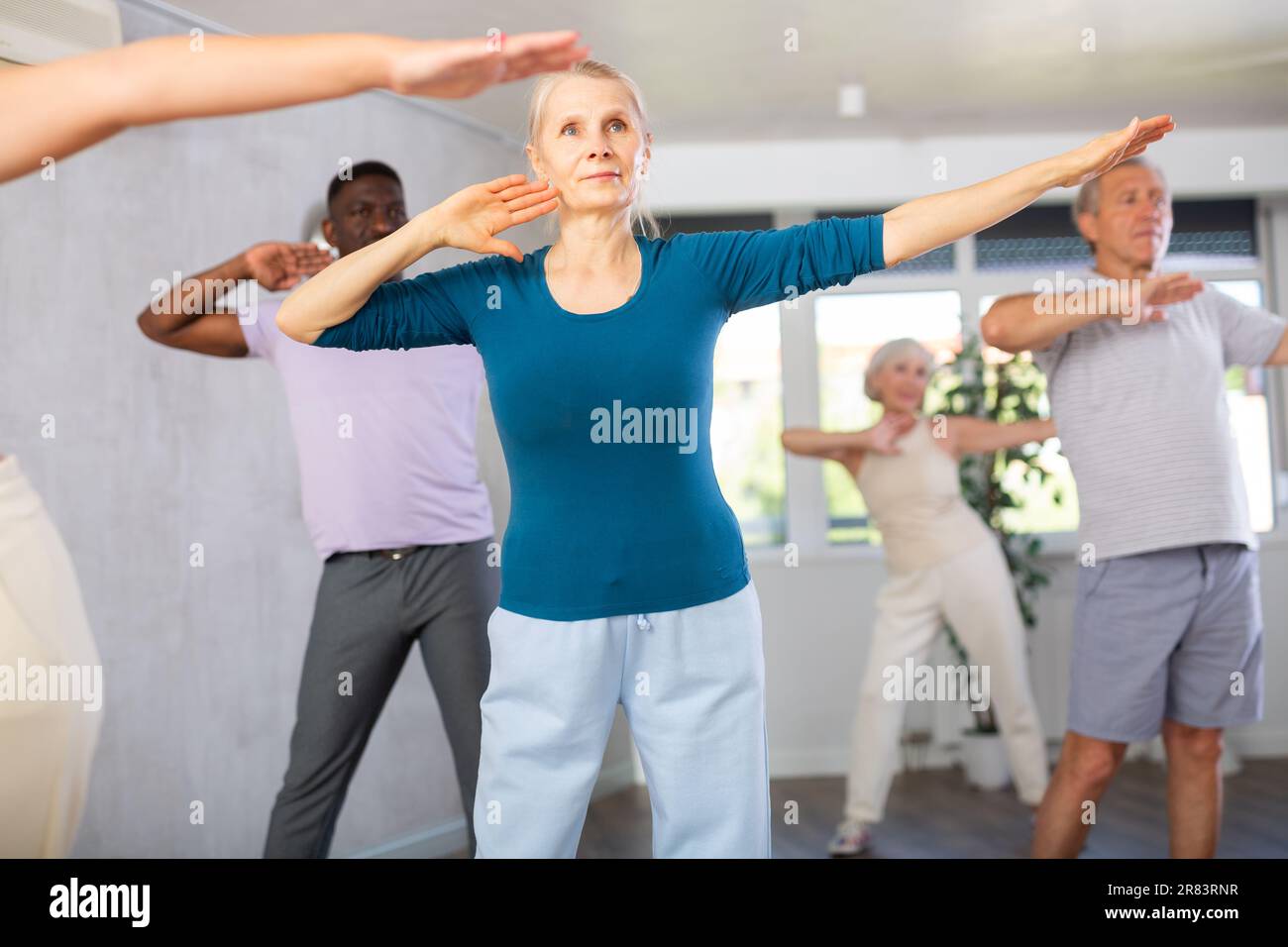Elderly woman dancing hip hop during group dance class Stock Photo - Alamy