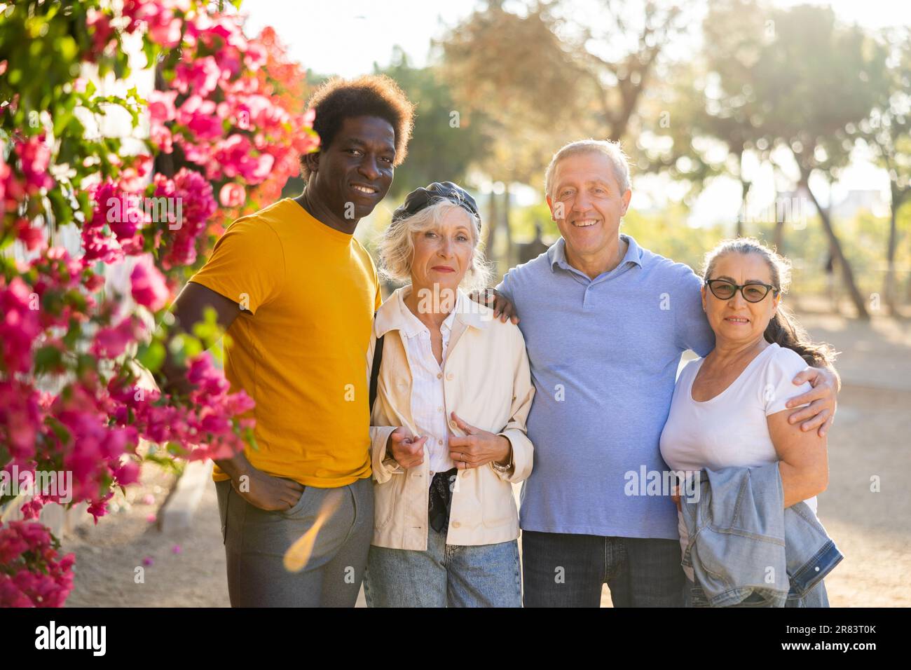 Portrait of happy friendly mature adult people standing outdoors ...