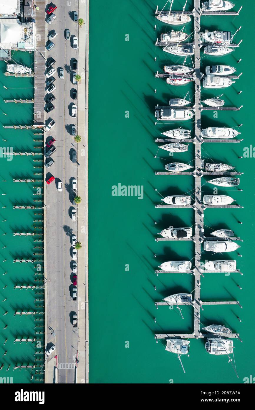 A scenic marina with a variety of boats docked in the harbor Stock ...