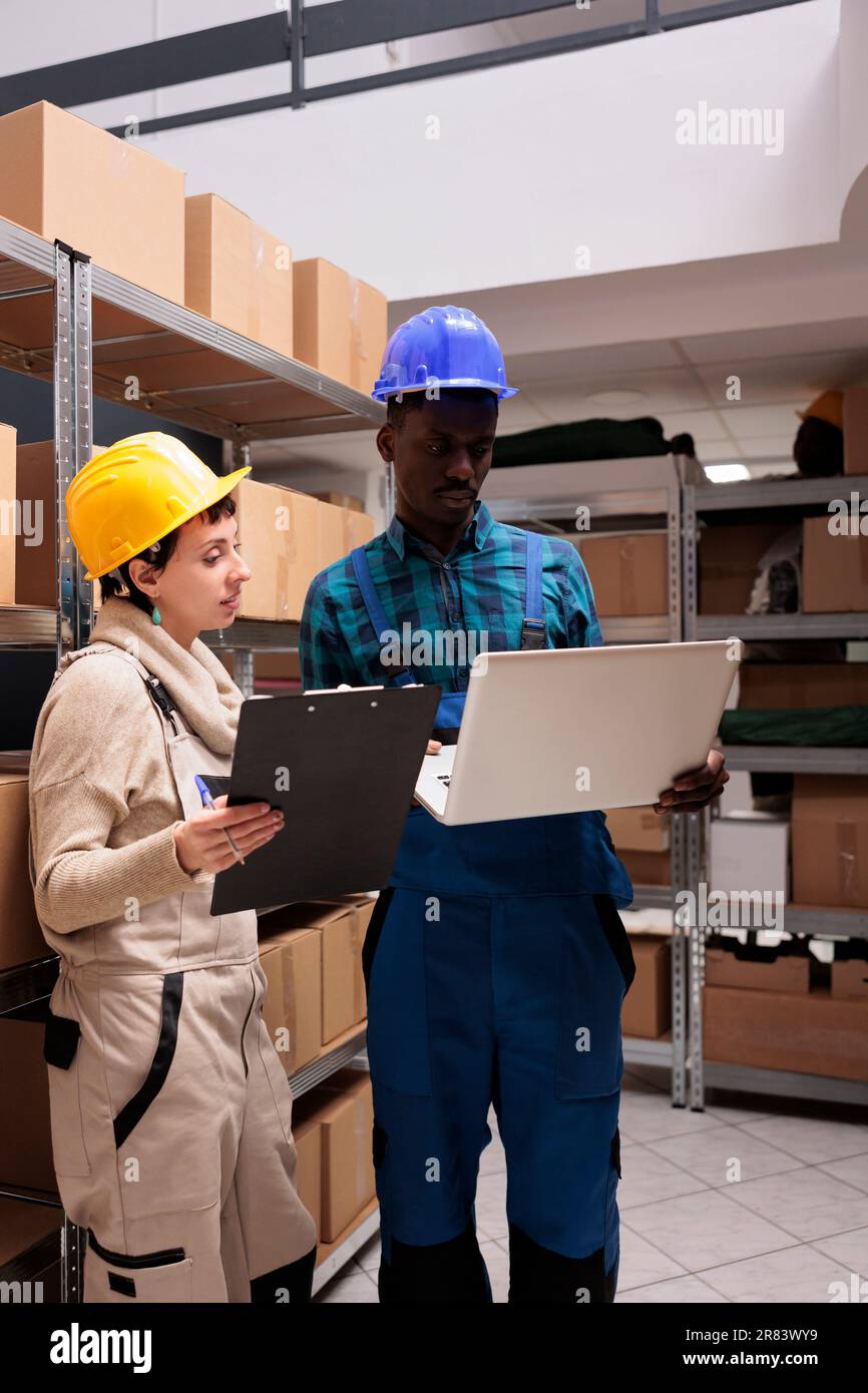 Two employees discuss inventory hi-res stock photography and images - Alamy