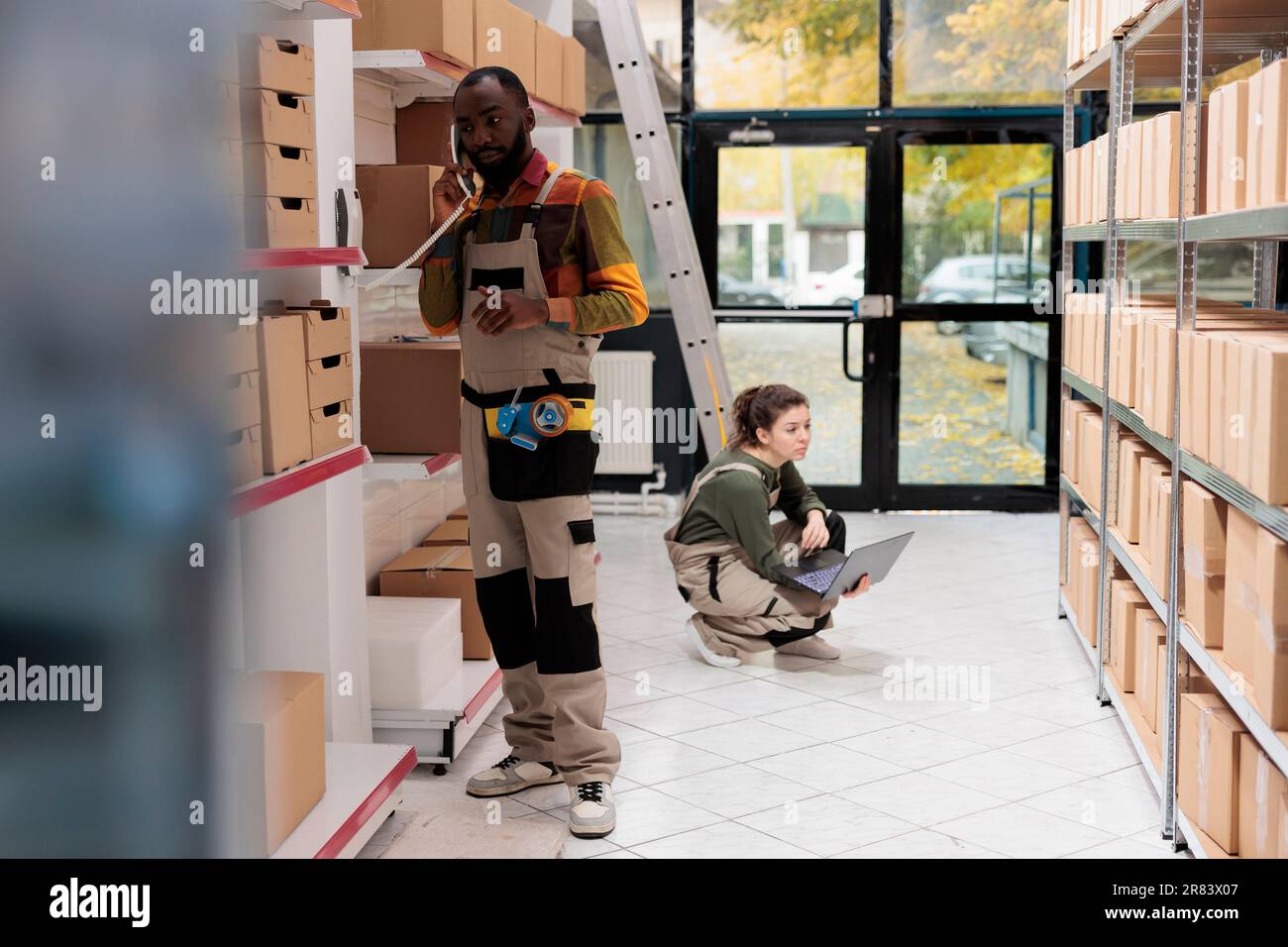 African american employee discussing goods stock supply with warehouse ...