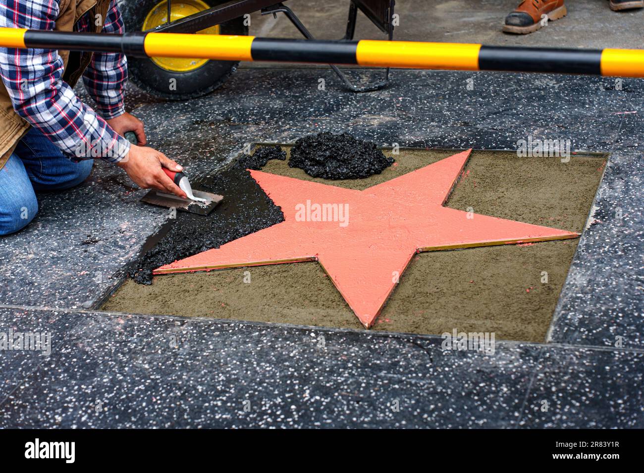 Worker carefully placing a star on the Hollywood Walk of Fame Stock ...