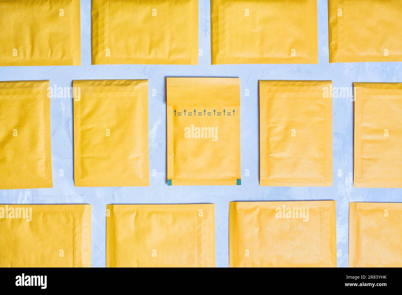 A top-down view of a set of yellow padded envelopes placed neatly side ...