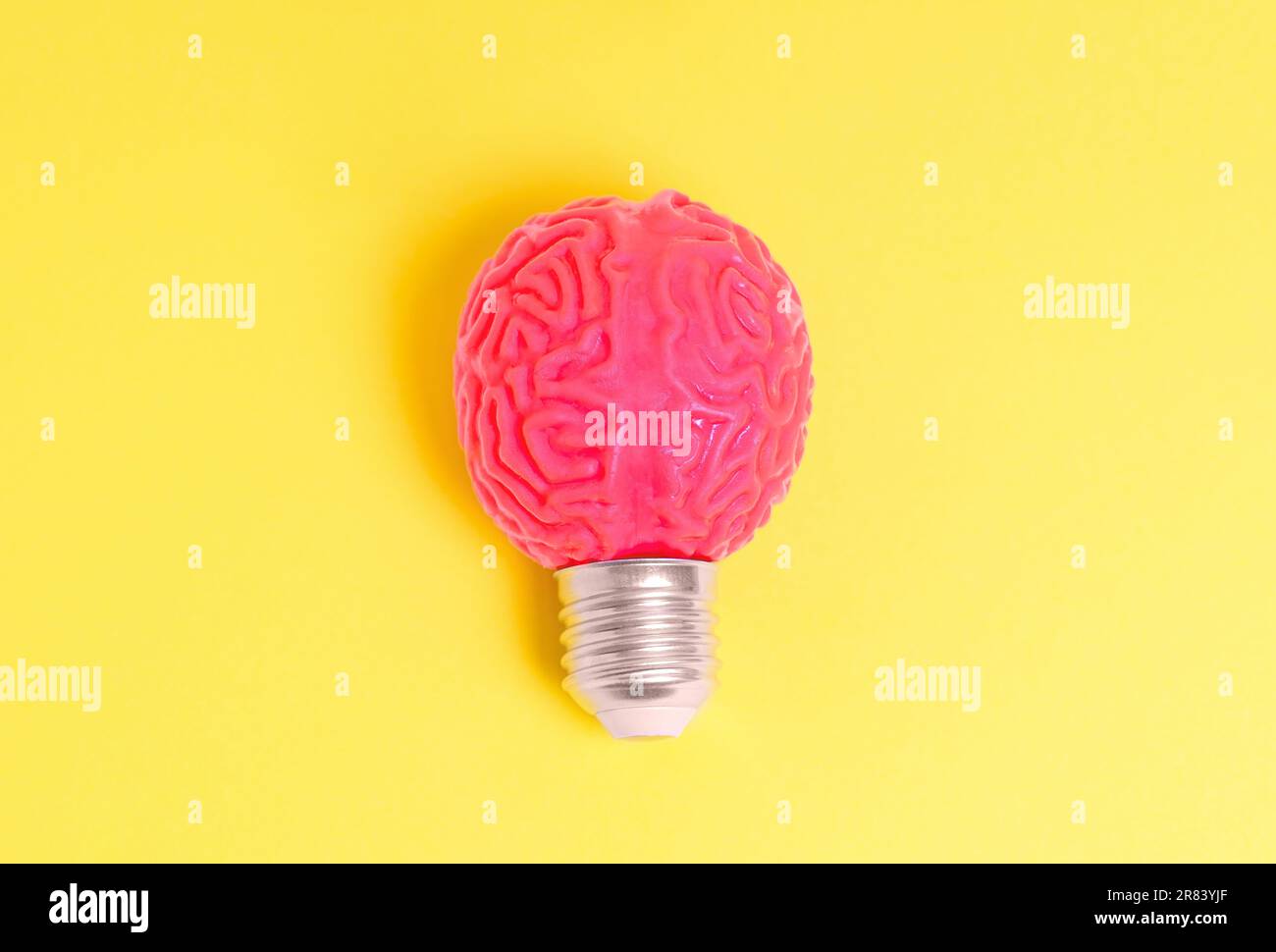 Human brain model and a bulb cap arranged into a light bulb symbol ...