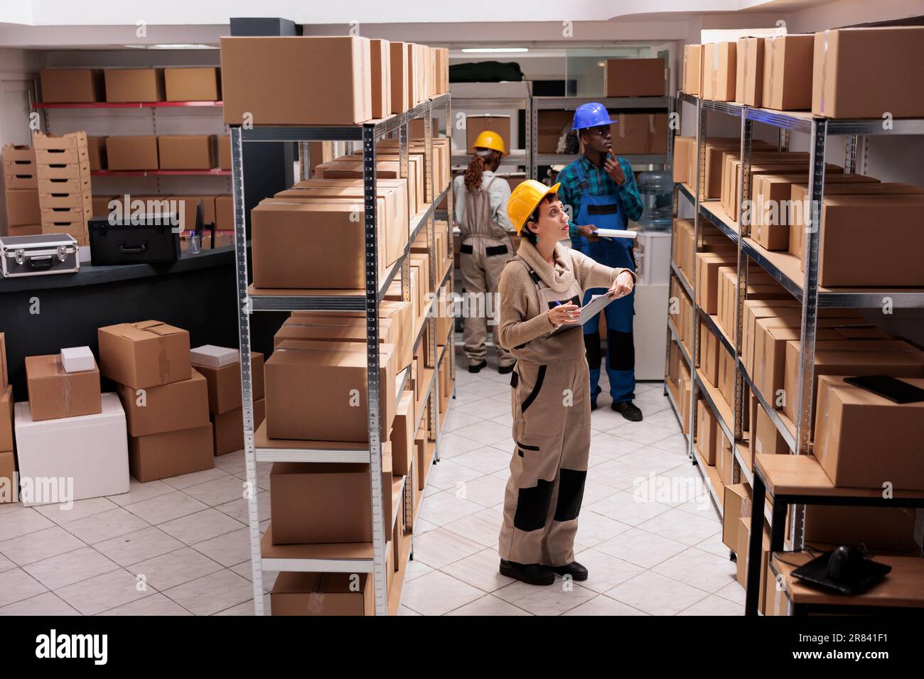 Delivery service worker searching customer parcel in warehouse and ...