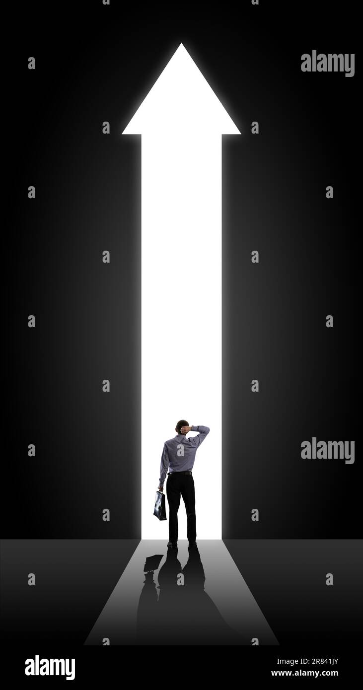 New beginning. Employee standing in front of giant arrow, new path in ...