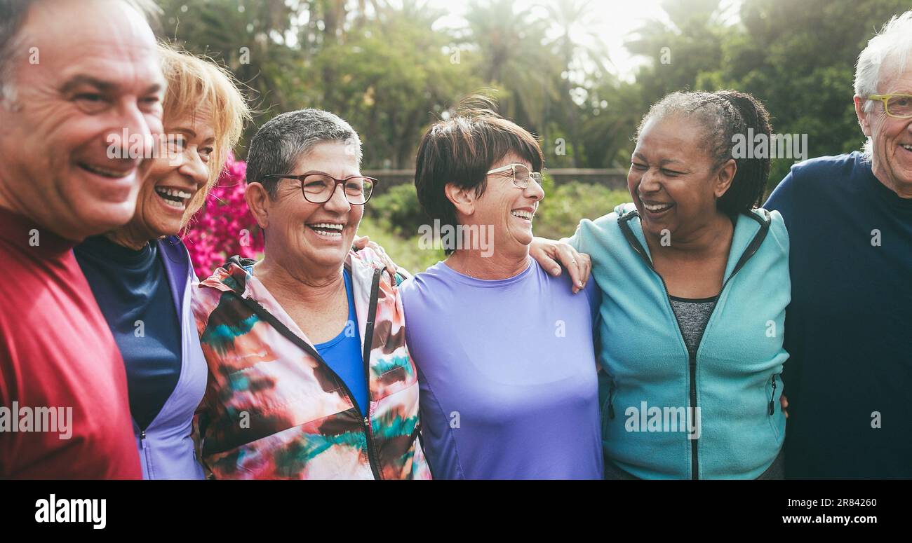 Multiracial senior people having fun hugging each other after sport ...