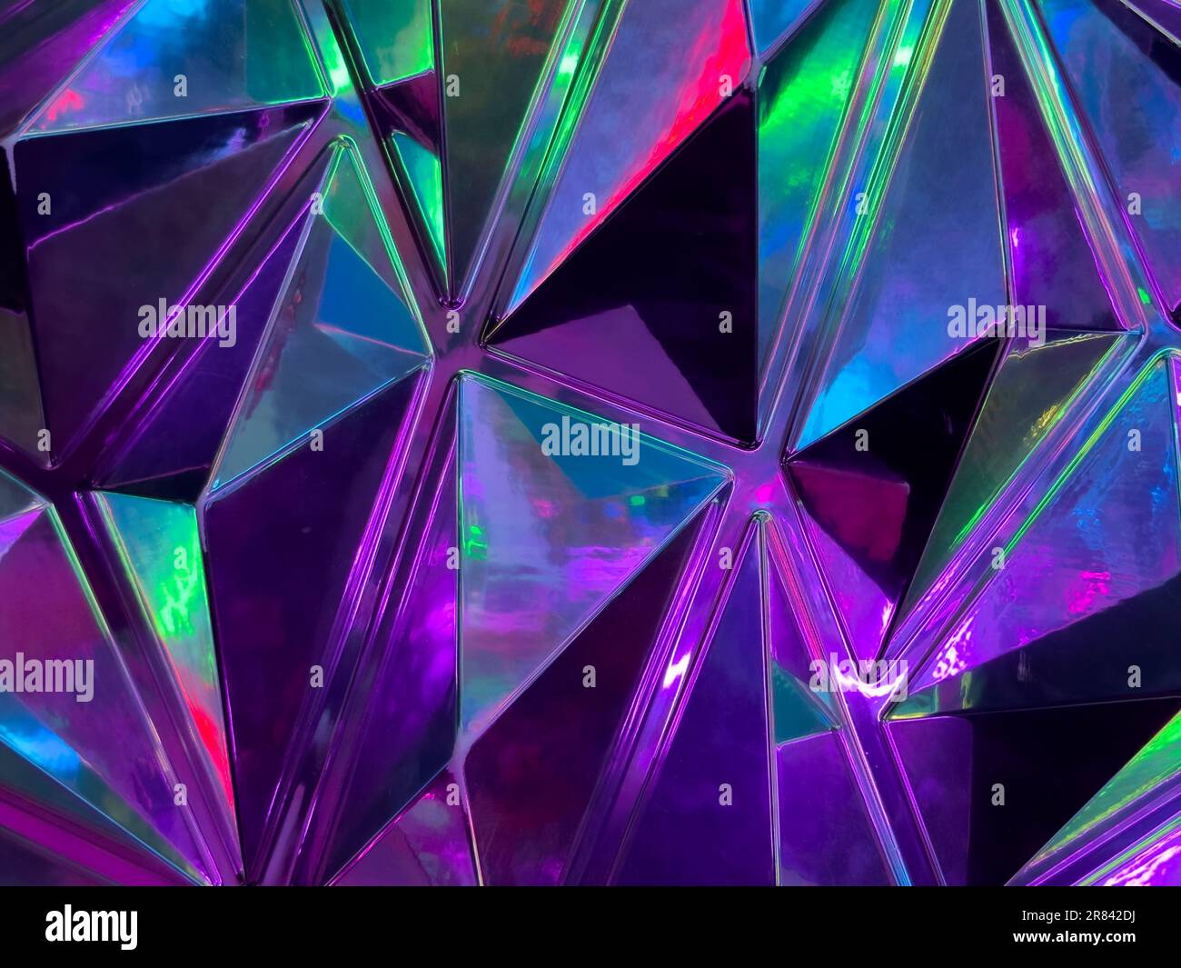 A colorful glass texture with various shapes and hues, shining brightly ...