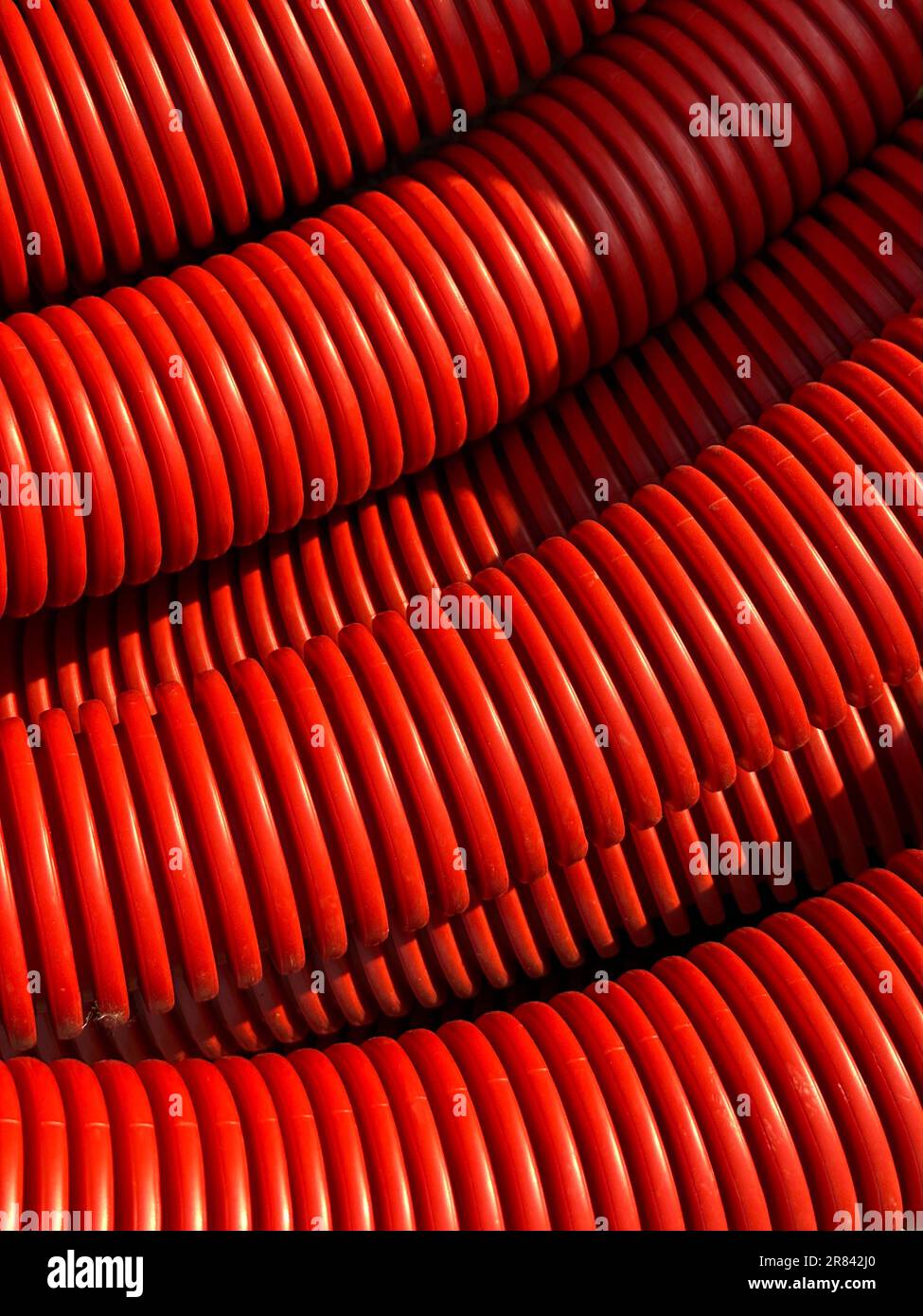 A symmetrical formation of red hoses in a cylindrical pattern Stock ...