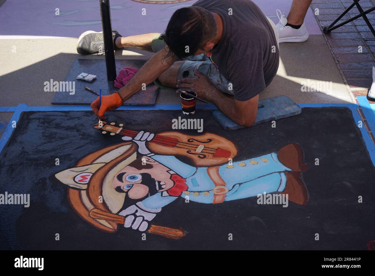 Pasadena, USA. 18th June, 2023. An artist paints with chalks during ...