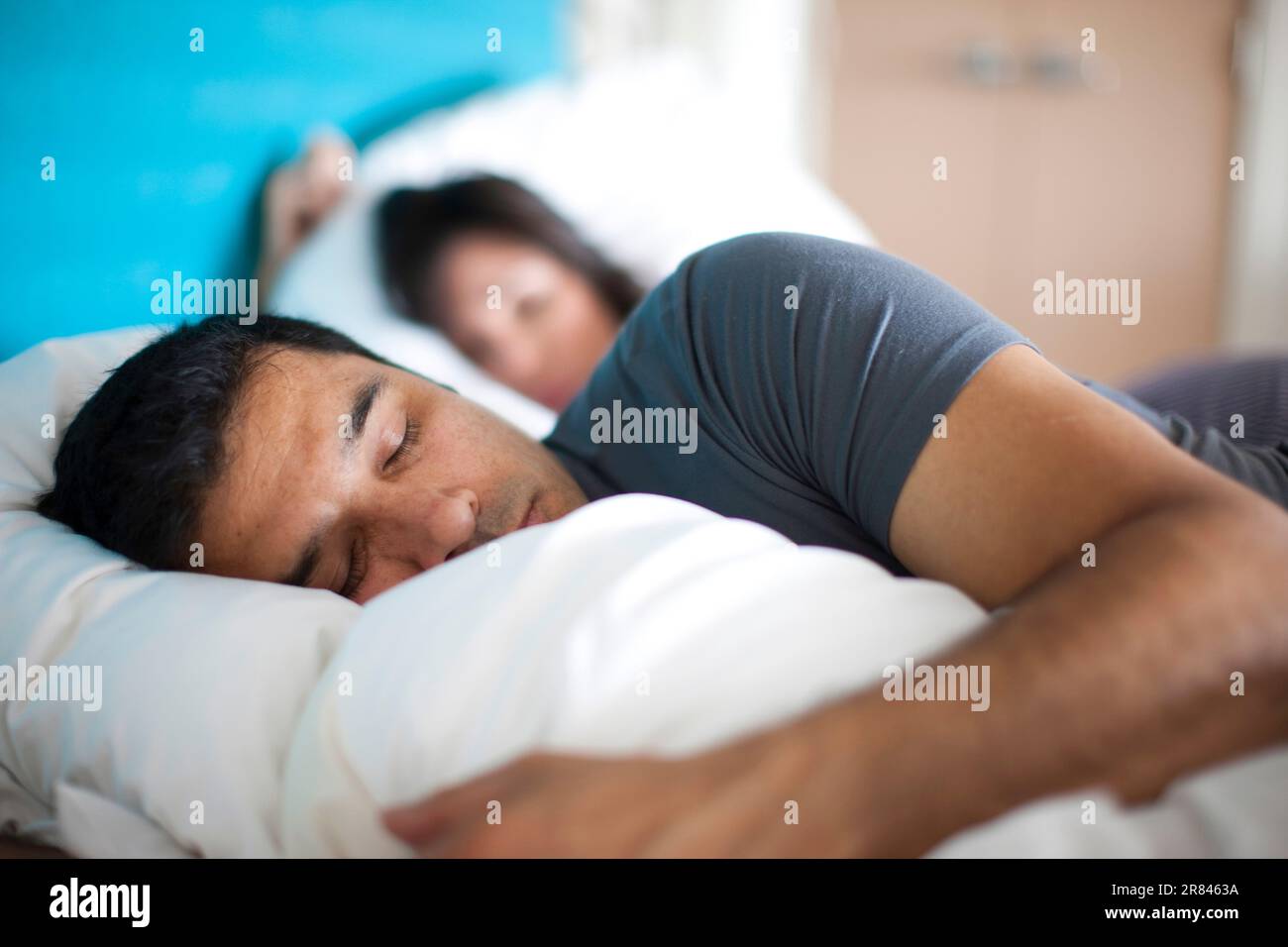 A man and woman sleeping in bed Stock Photo - Alamy