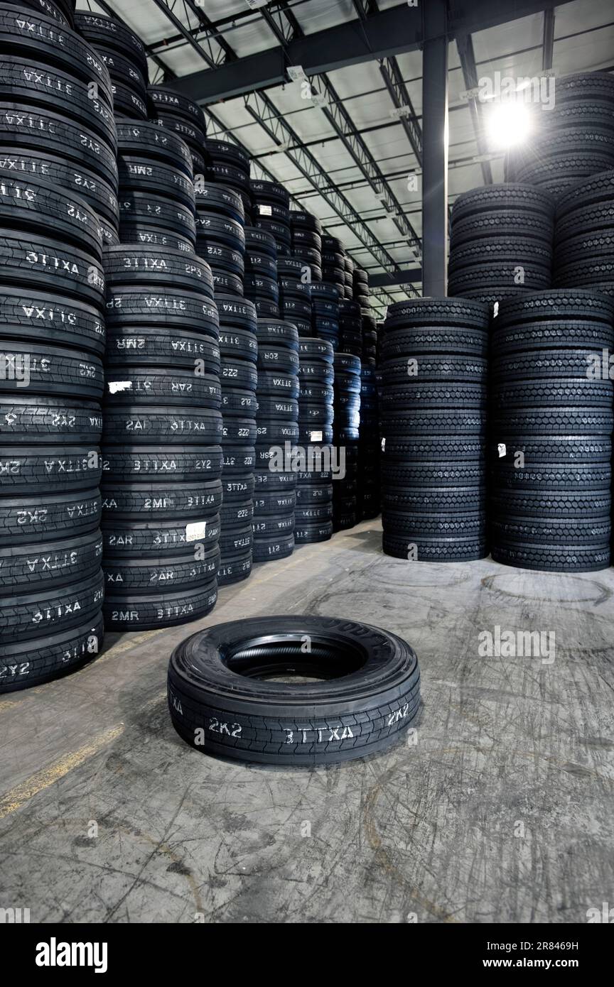 A Warehouse housing rows and rows of new tires for trucks and cars ...