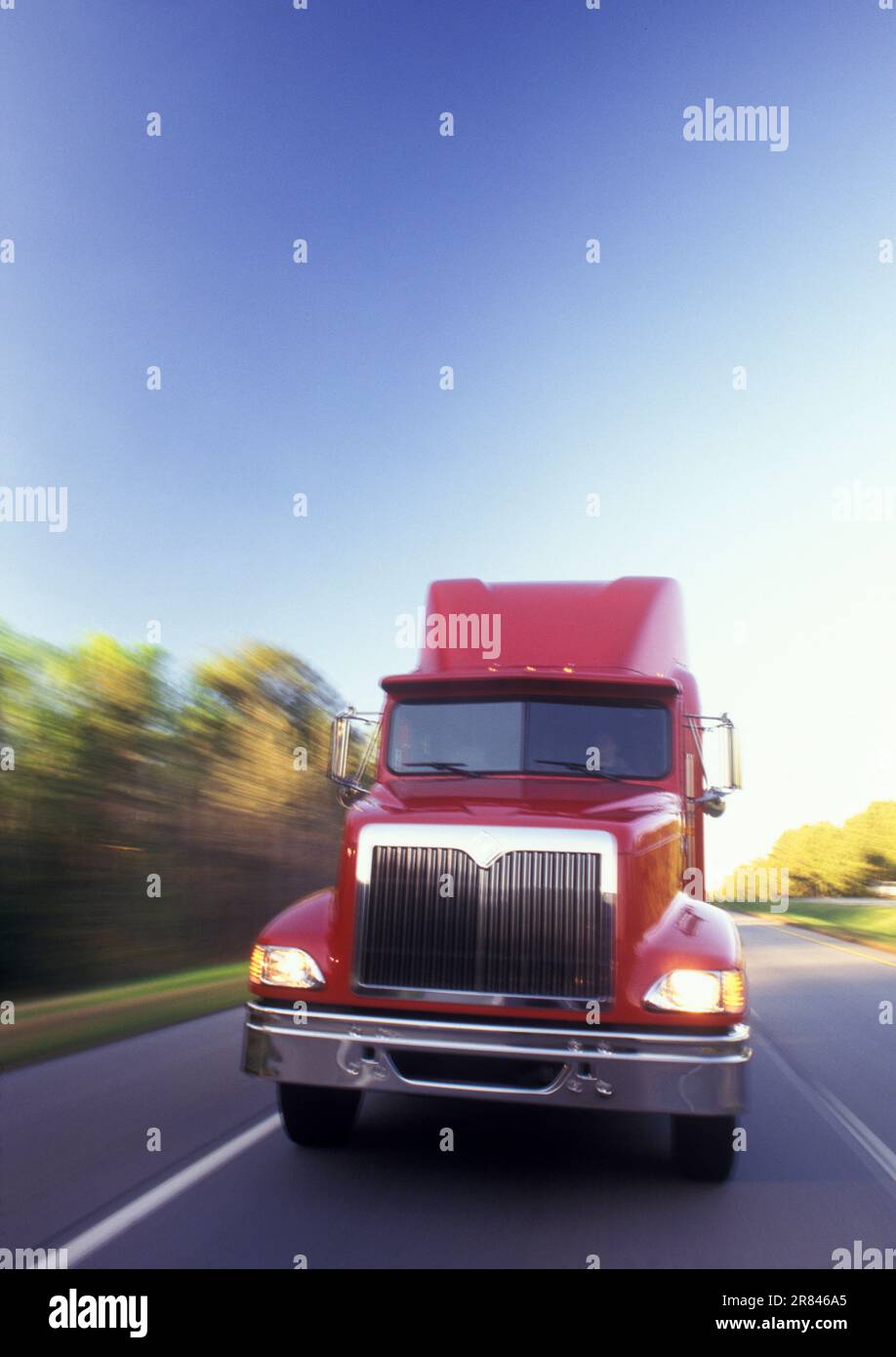 Red semi truck in motion Stock Photo - Alamy