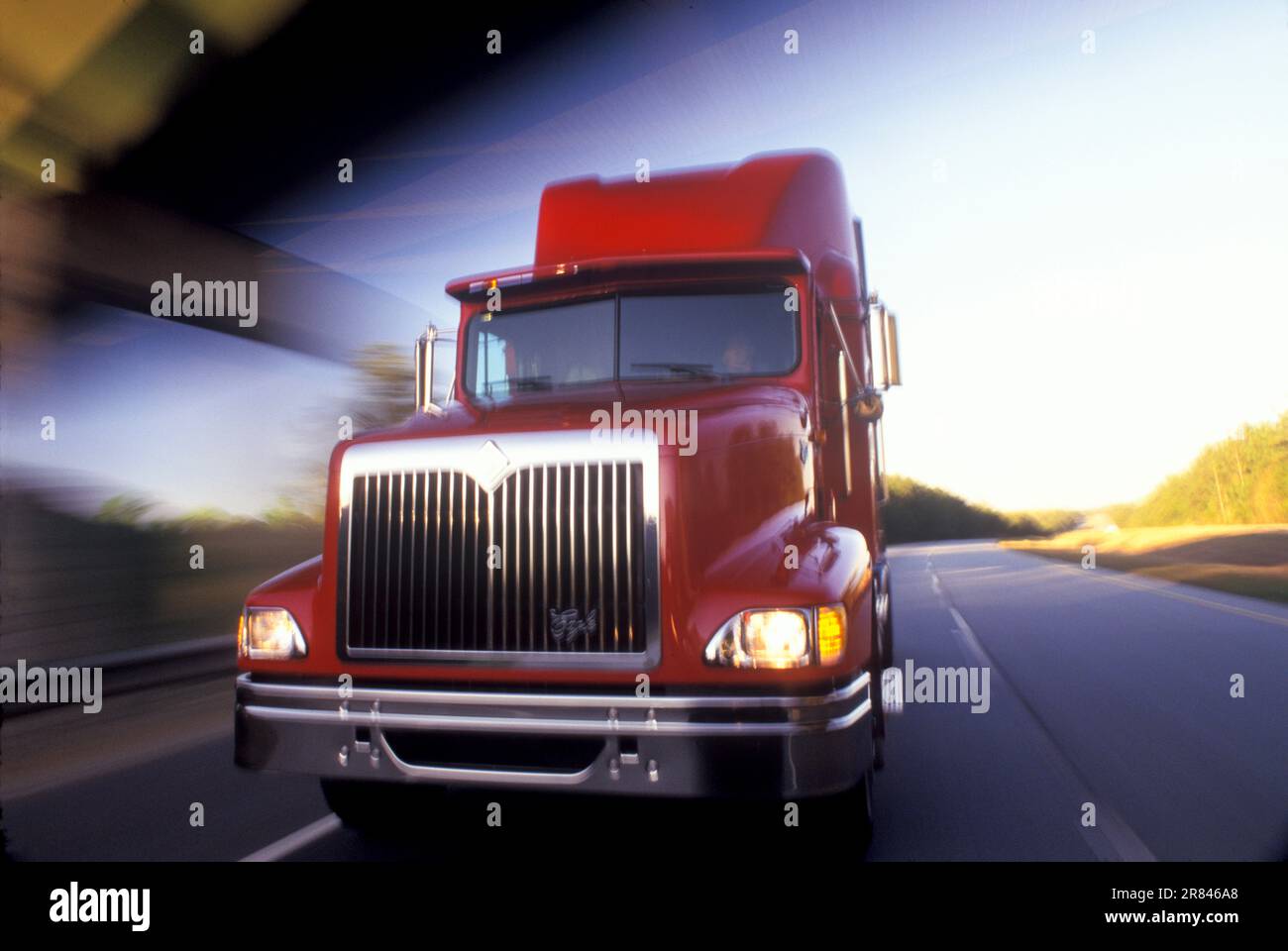 Red semi truck in motion Stock Photo - Alamy