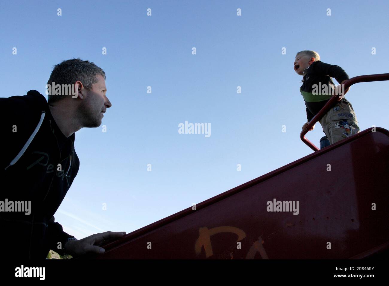 A father watches his autistic son playing in Stockholm, Sweden Stock ...