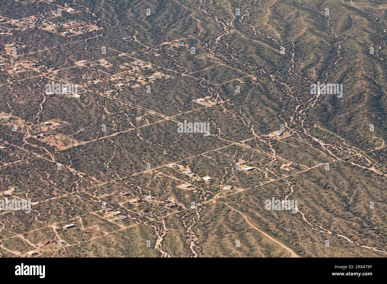 Aerial view of sparse development and unpaved roads in the outskirts of ...