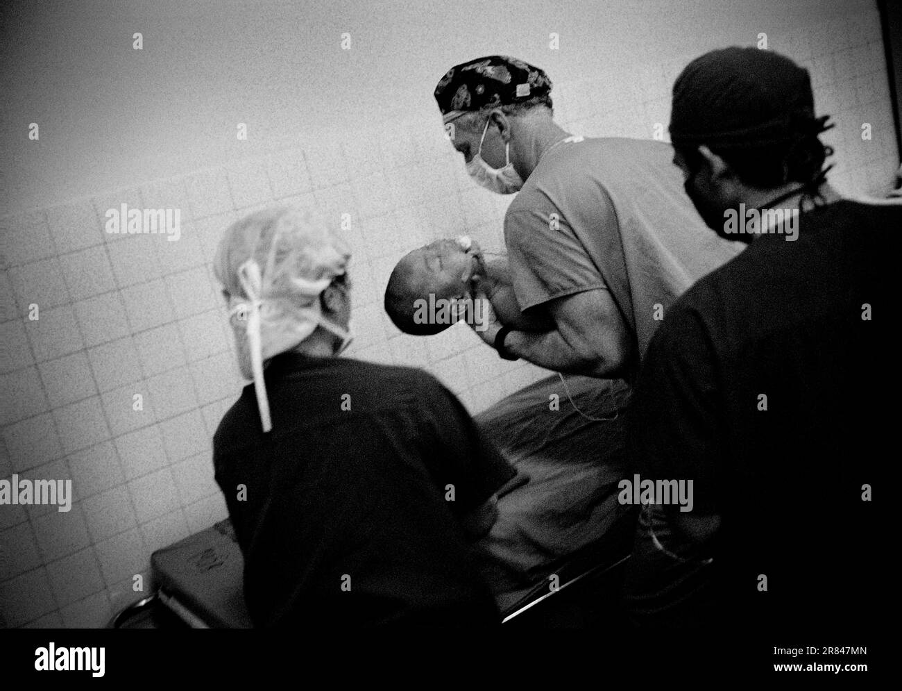 Surgeon prepares a child for surgery at Hanoi Pediatrics Hospital Stock ...