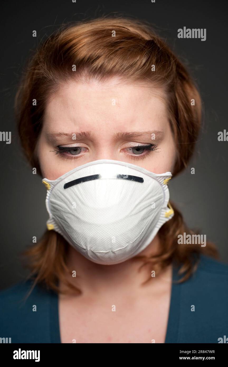 Studio portrait of 24 year old caucasian female wearing a N95 mask ...