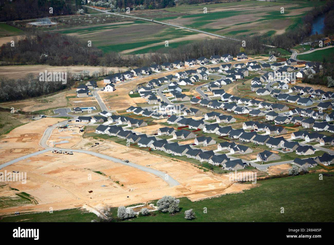 Aerial view of dense suburban housing development halted by the real ...