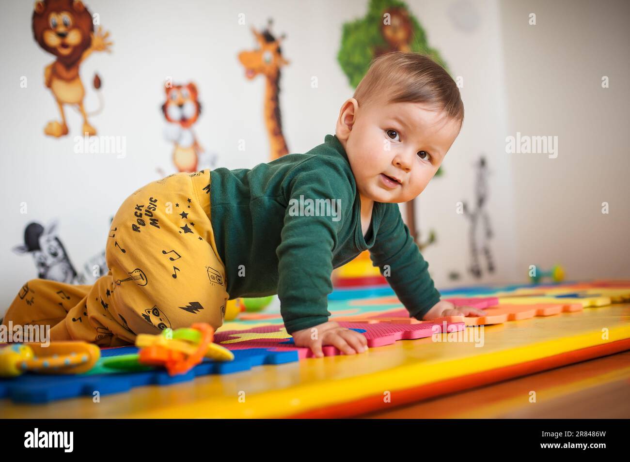 Cute baby boy crawls on the home floor, explore the world and learn to ...