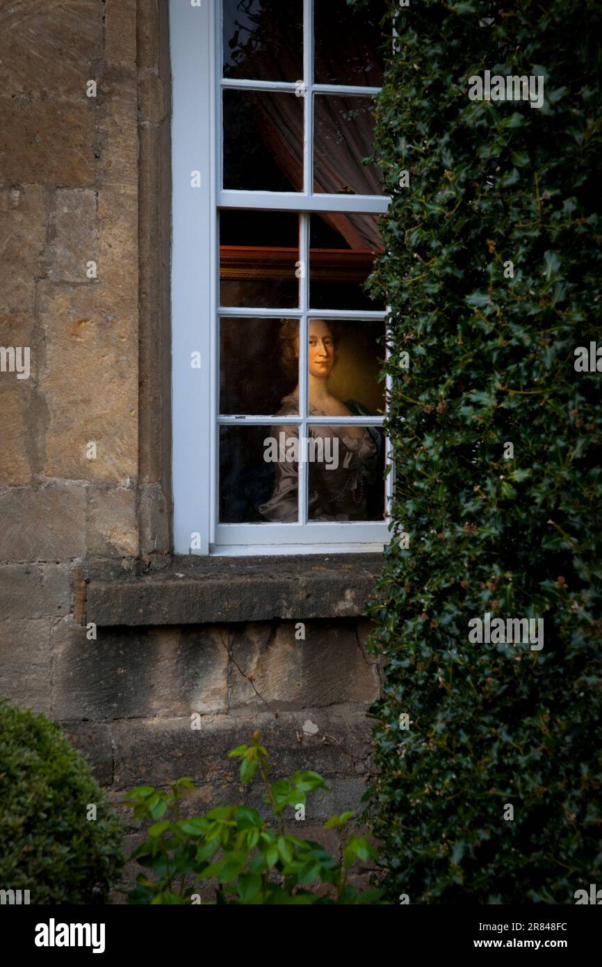 Paintings peer out through the window of a Fine Art Gallery in Broadway ...