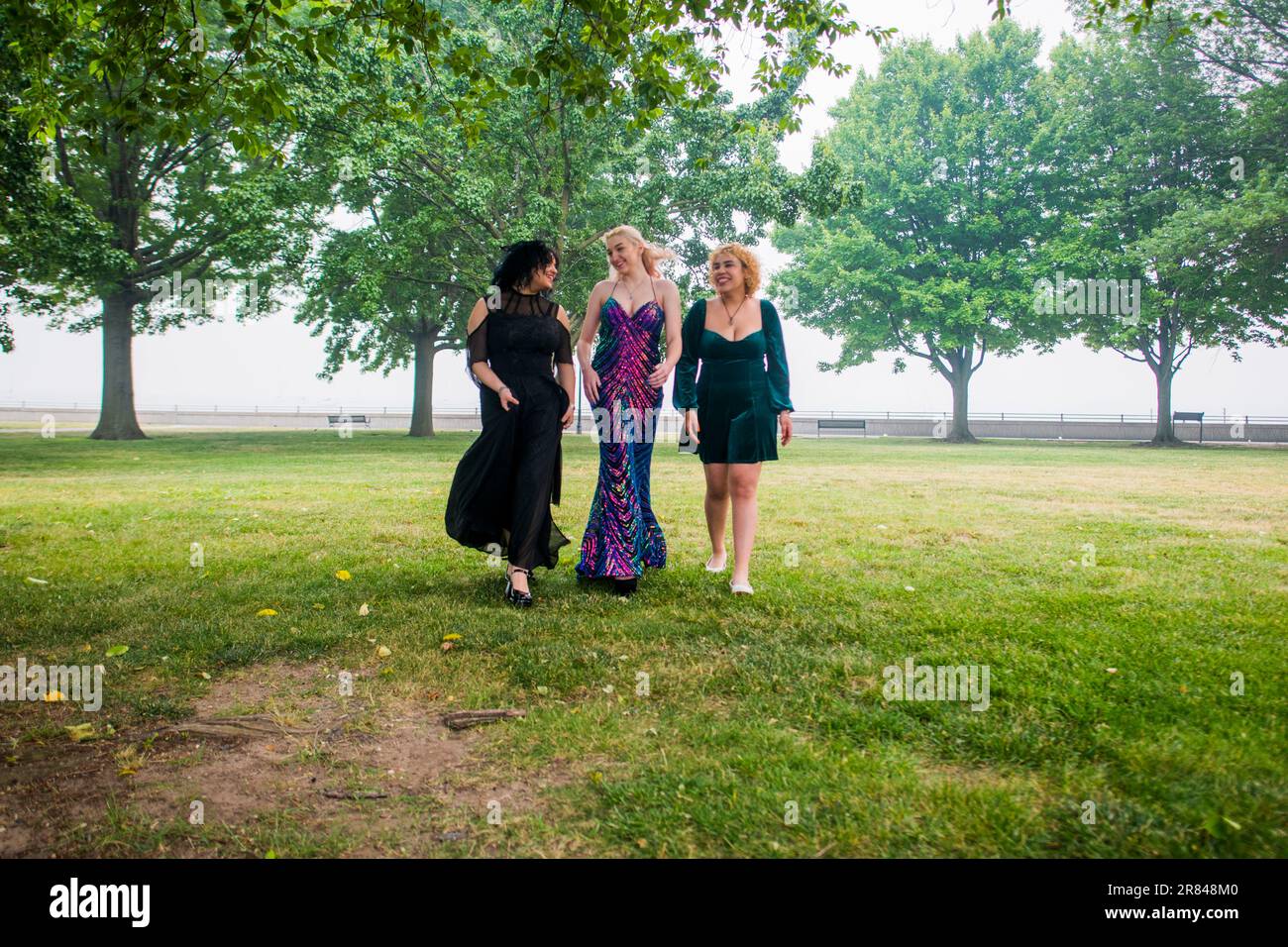 Best friends Dressed for the senior Prom in Park Posing for pictures ...