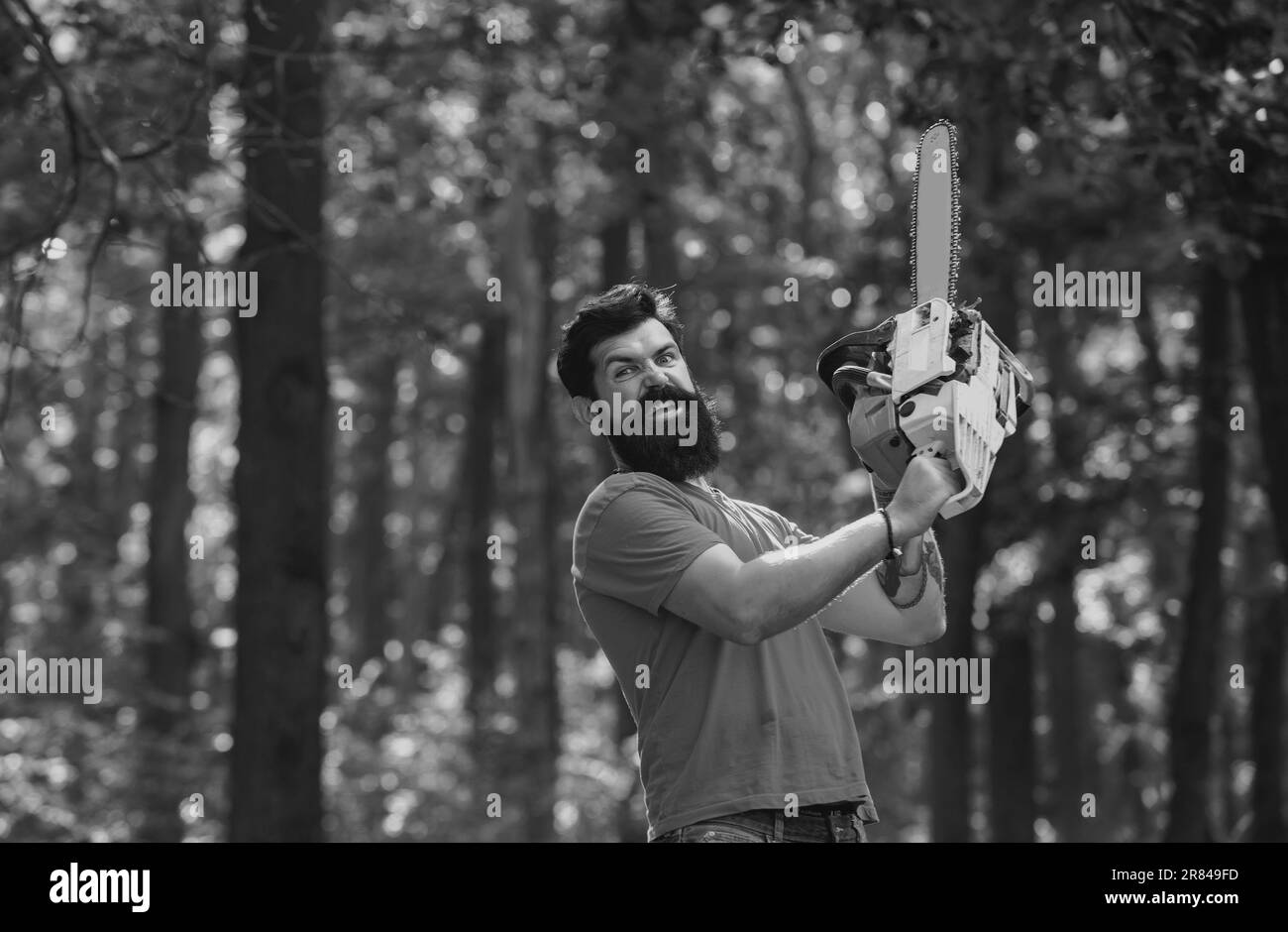 Lumberjack worker with chainsaw in the forest. Lumberjack worker ...