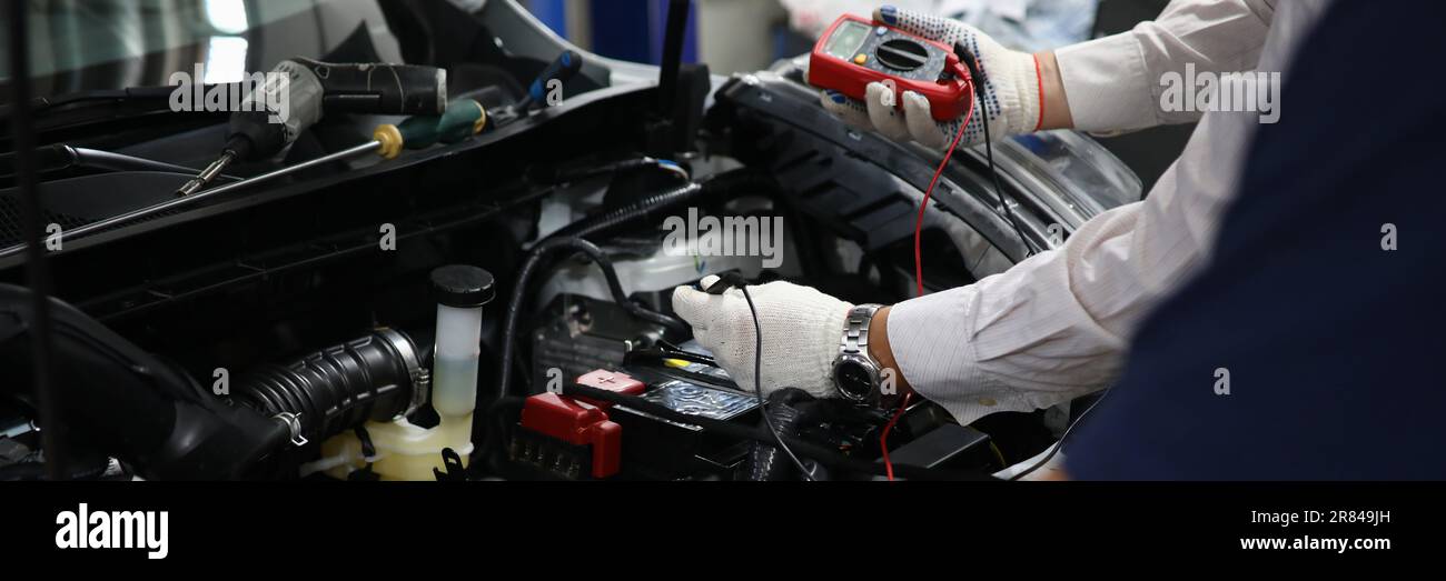 Professional auto mechanic works in a car service and tests operation ...