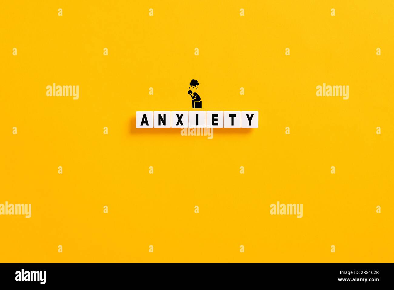White letter blocks on yellow background with the word anxiety. Anxiety ...