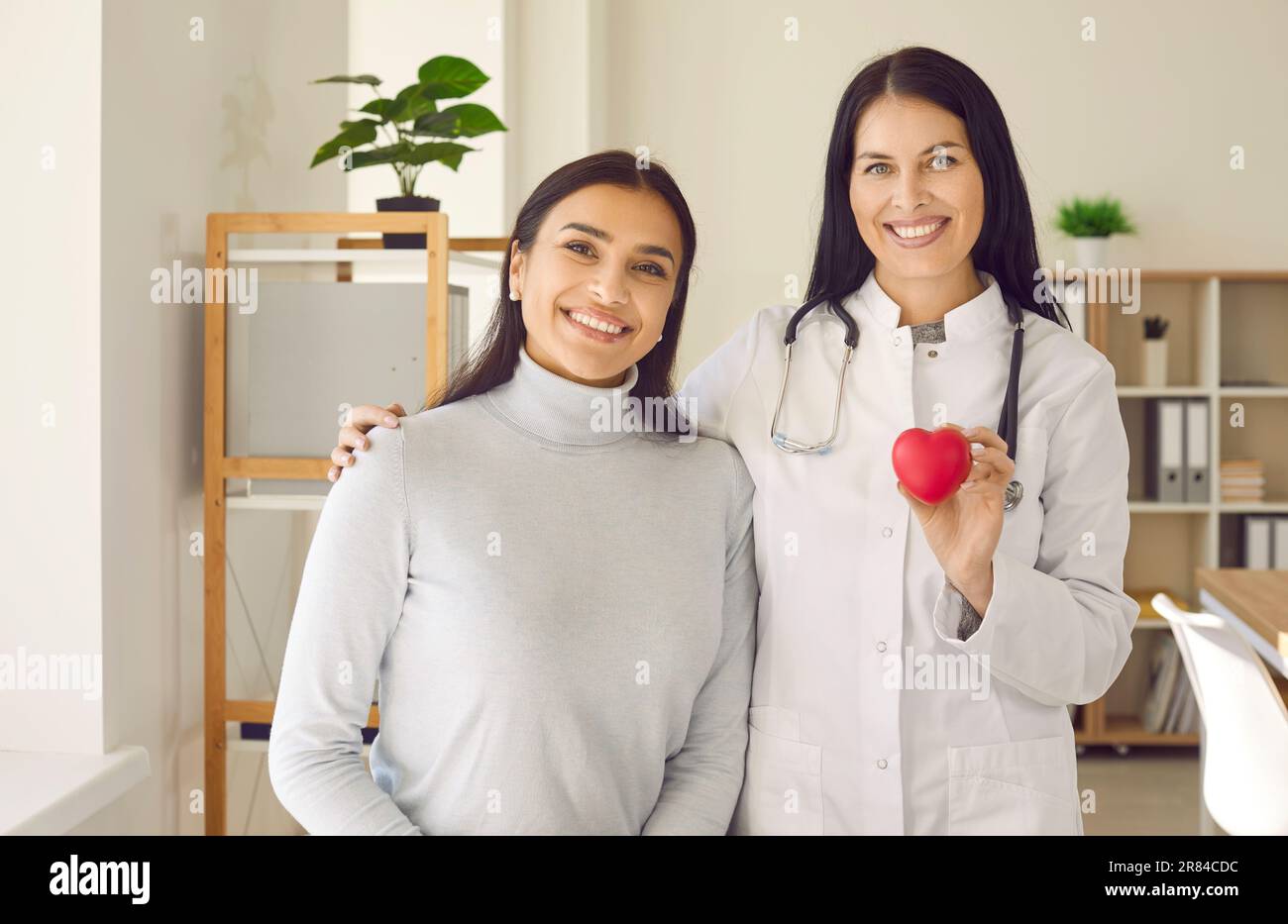 Portrait of two happy healthy women, cardiologist and her patient, with ...