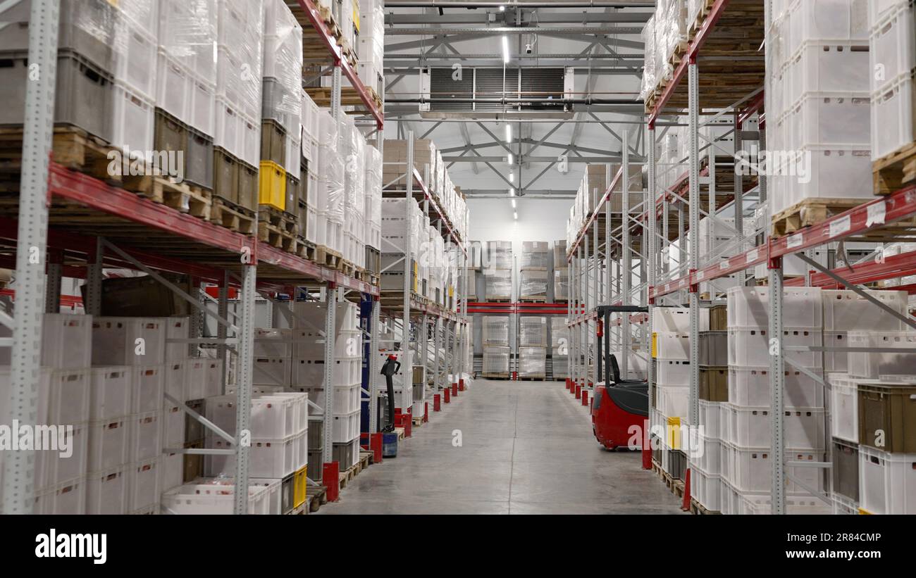 Warehouse interior. Large industrial warehouse. Tall metal shelves ...