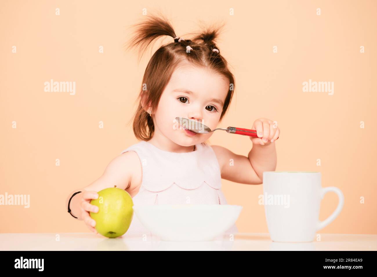 Cute baby food, babies eating. Kid eating healthy food with a spoon at ...