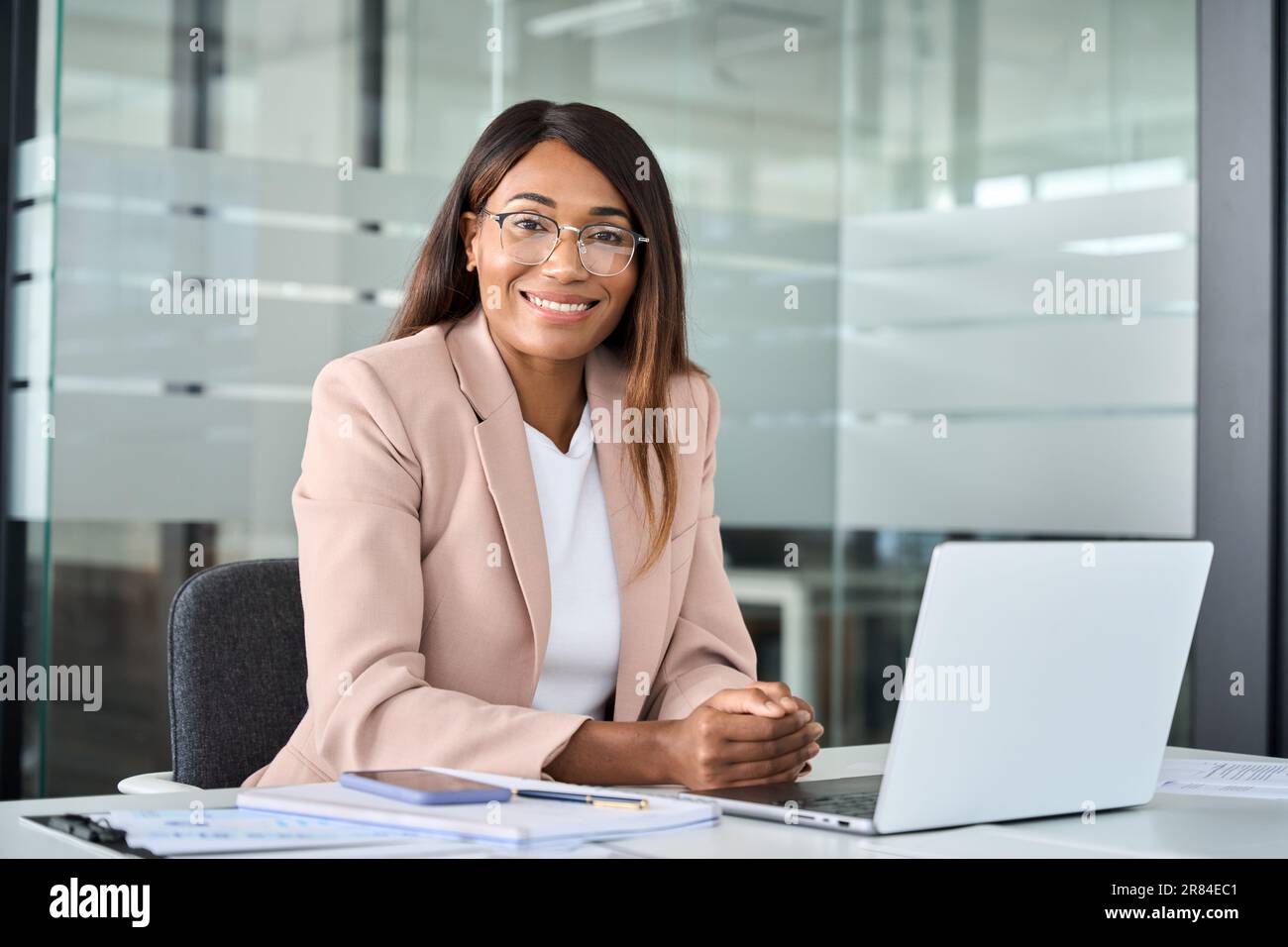 Professional woman in suit sits hi-res stock photography and images - Alamy