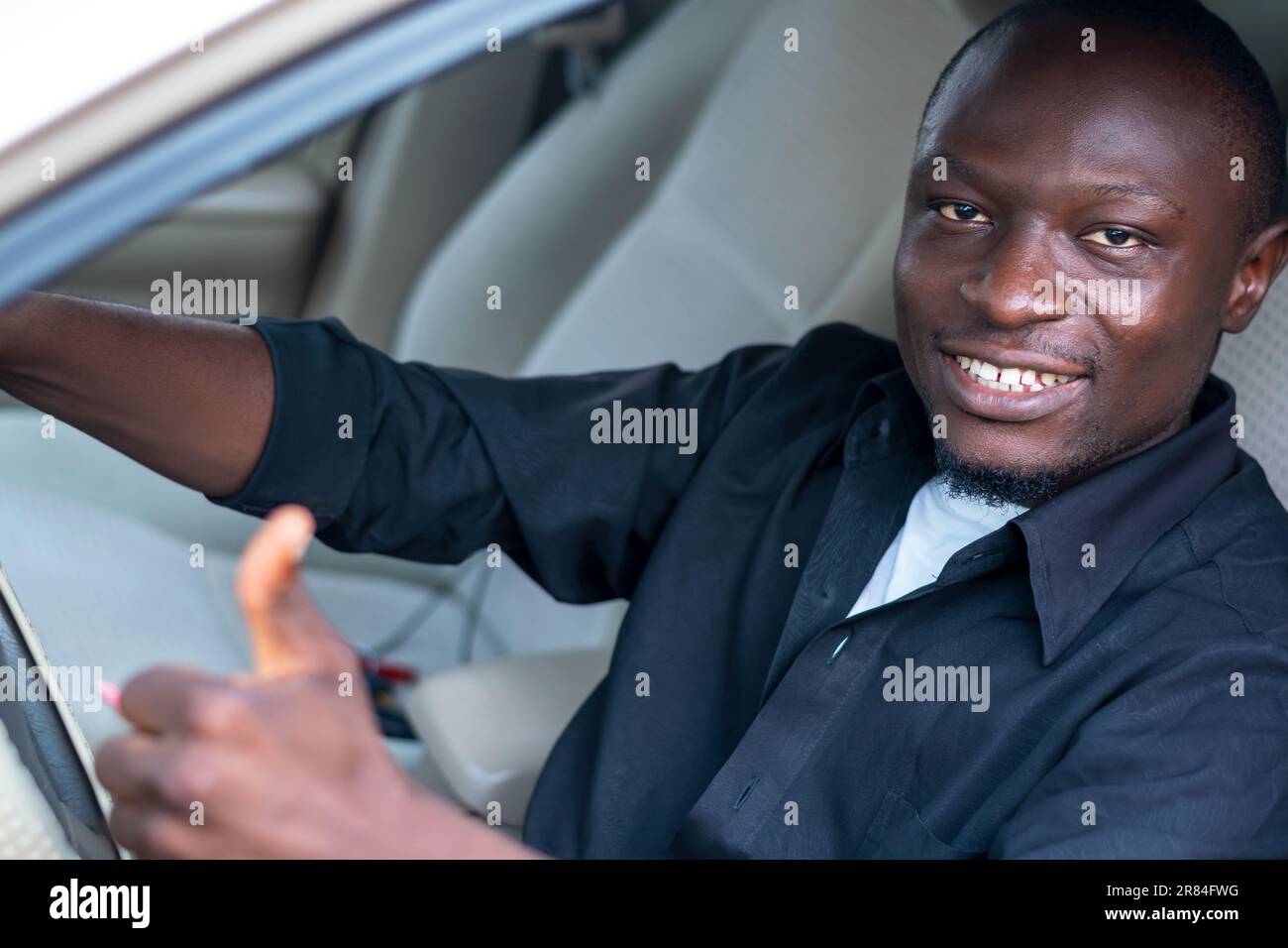 Smiling African driver giving thumbs up showing sign of approval Stock ...