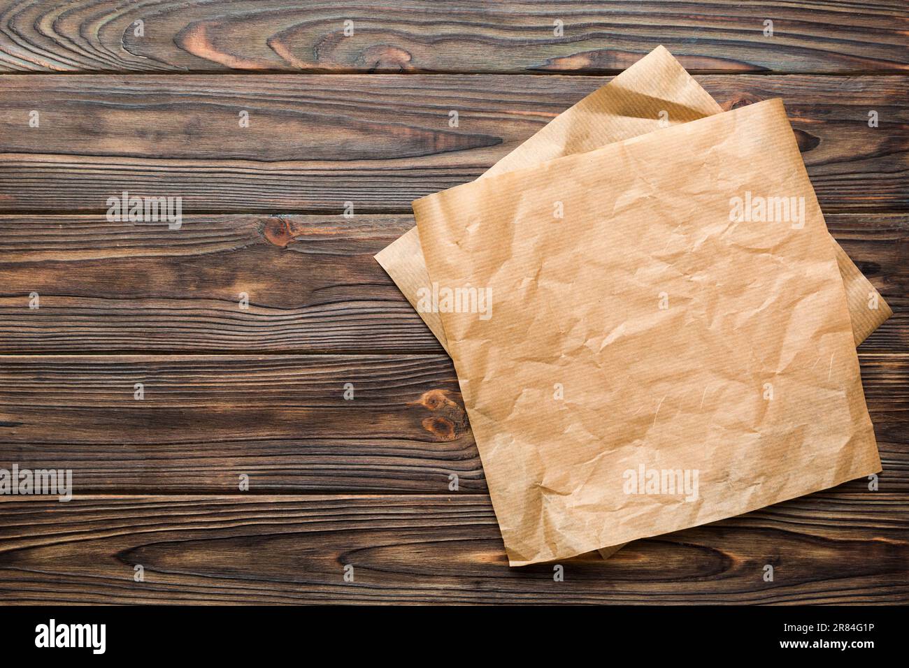 top view with baking parchment empty on table background. Folded cloth ...