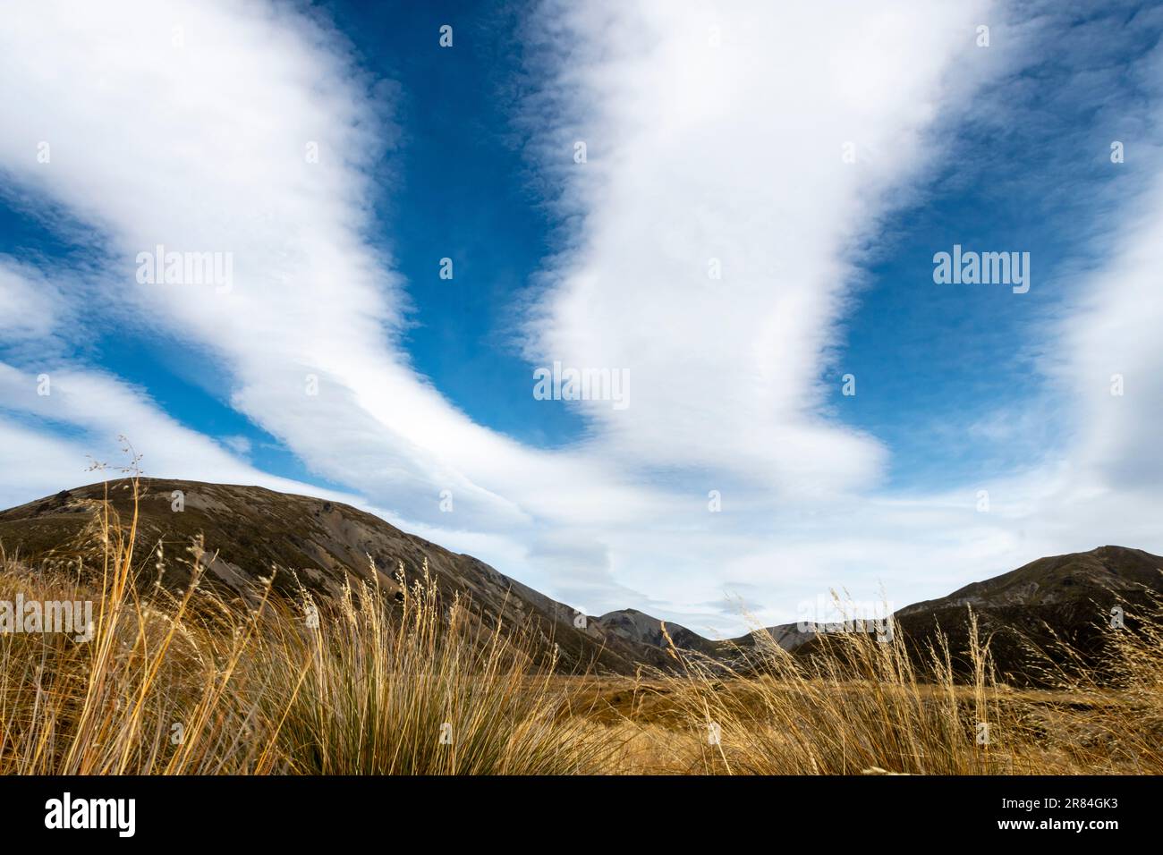 Long clouds over mountains and tussock, Lake Tennyson, near Hanmer ...