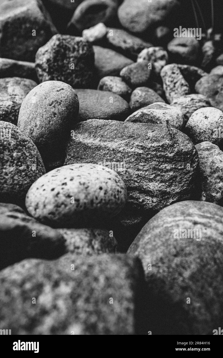 A grayscale of different stones arranged with a blurry background Stock ...