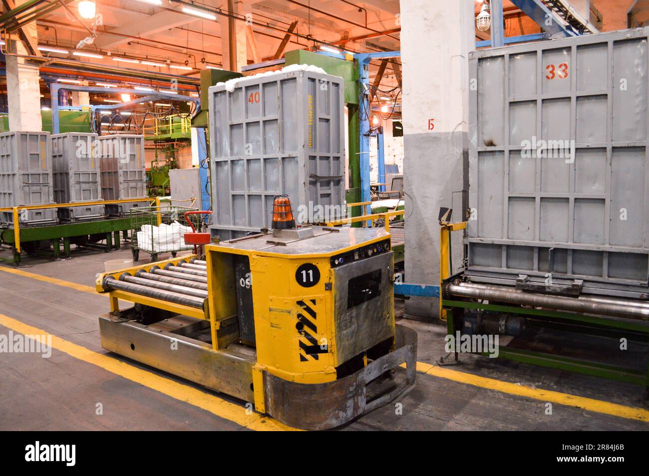 Self-propelled, autonomous yellow metal trolley, machine with a lamp ...