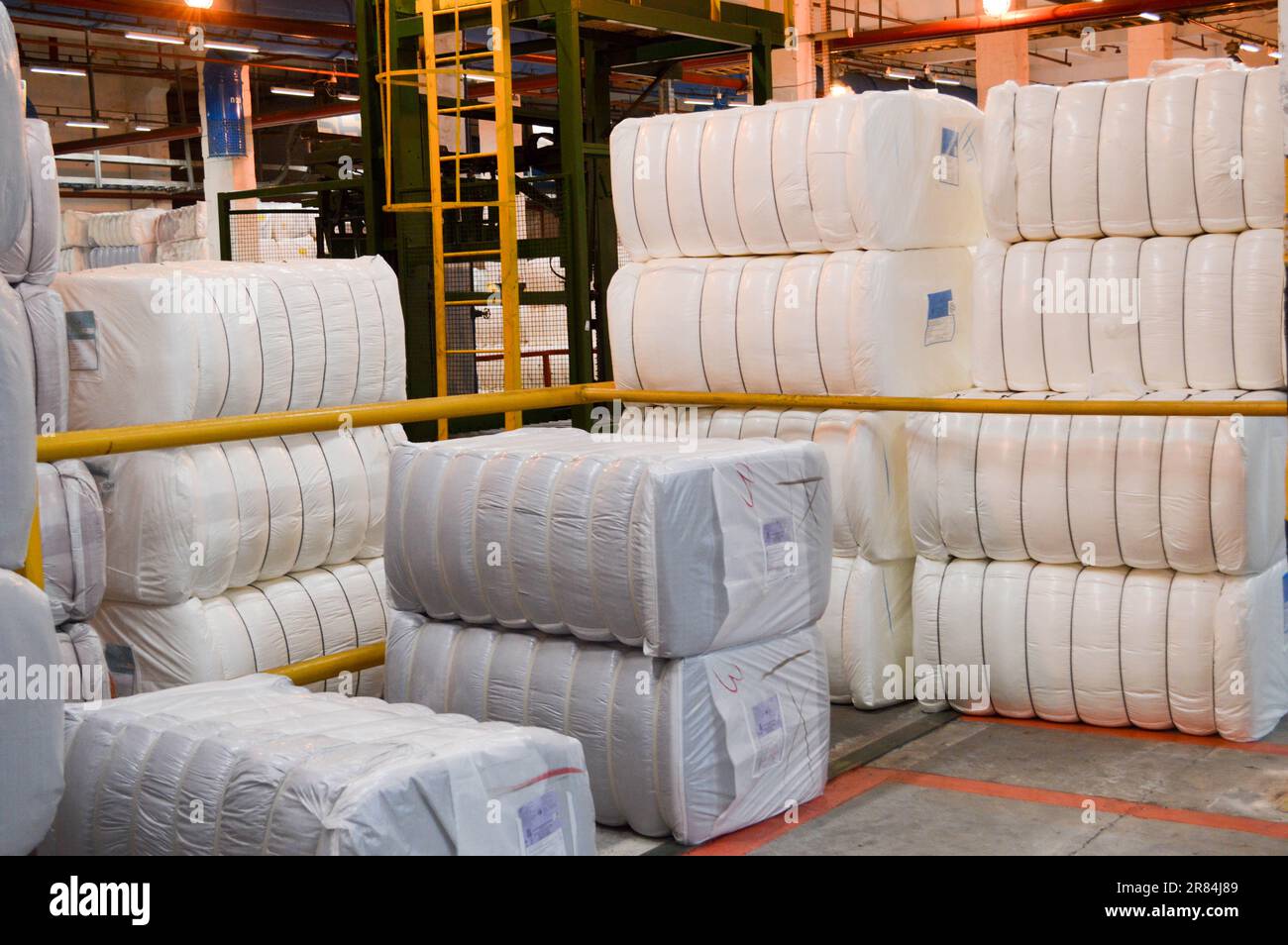 Large white packages, bags with synthetic acrylic fiber in a warehouse ...