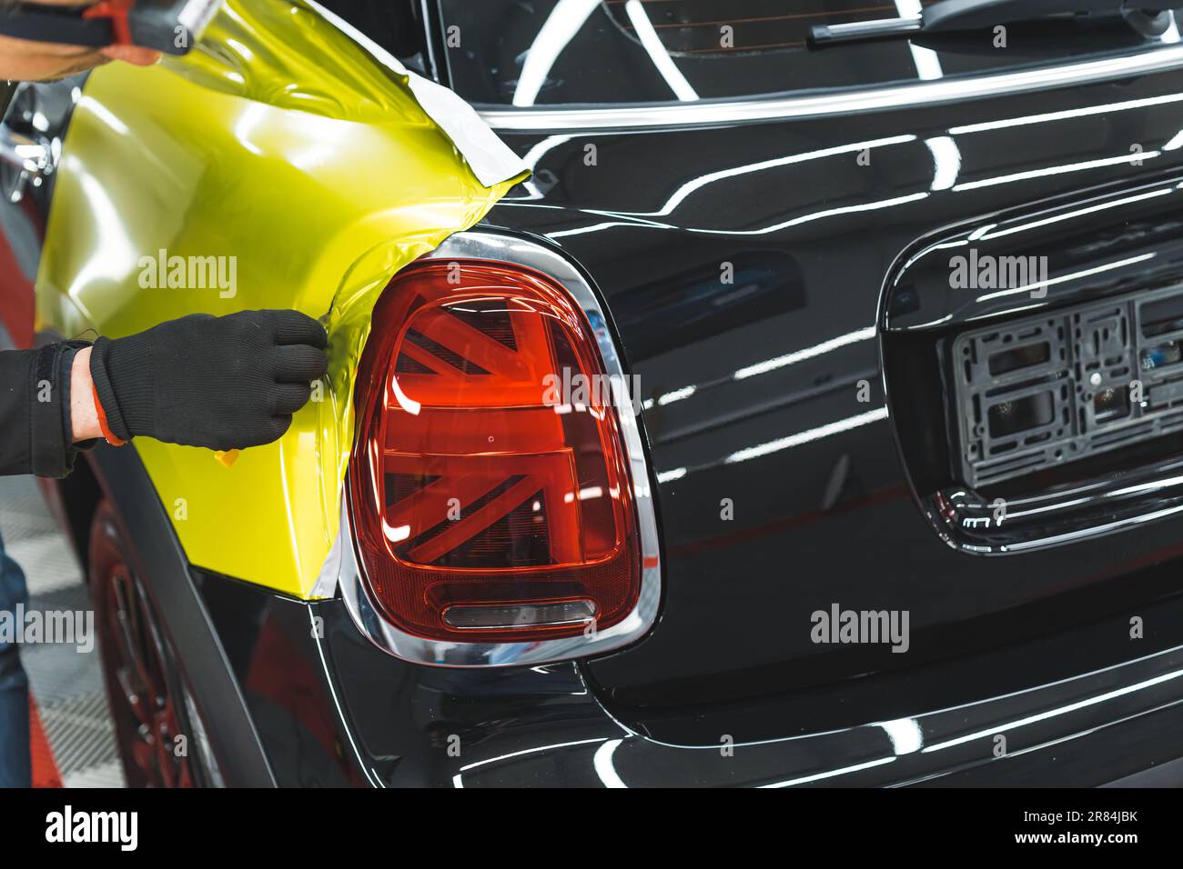 Car detailing concept. Car wrapping process done by a specialist in ...