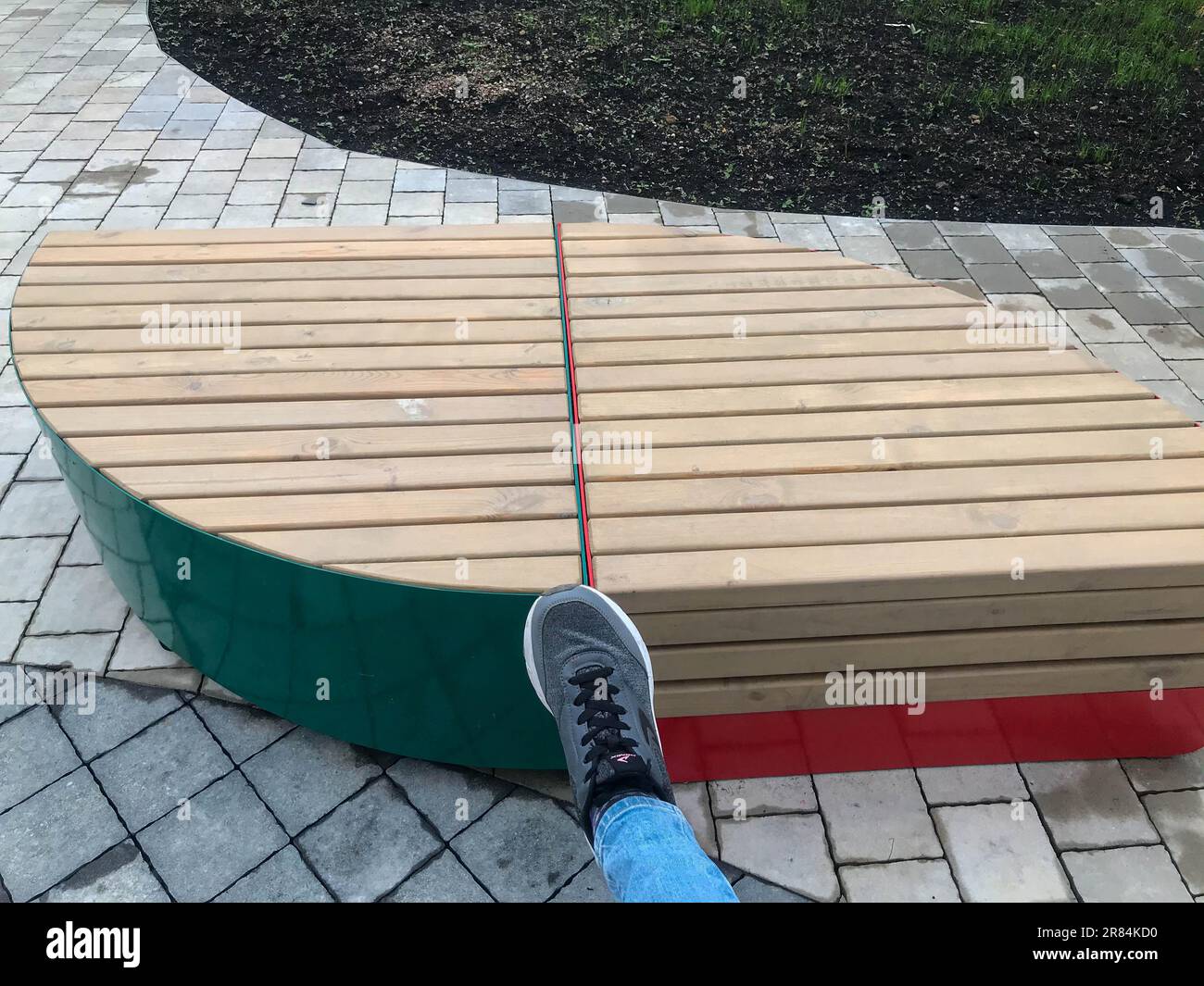 a wooden bench in the center of the residential complex in the form of ...