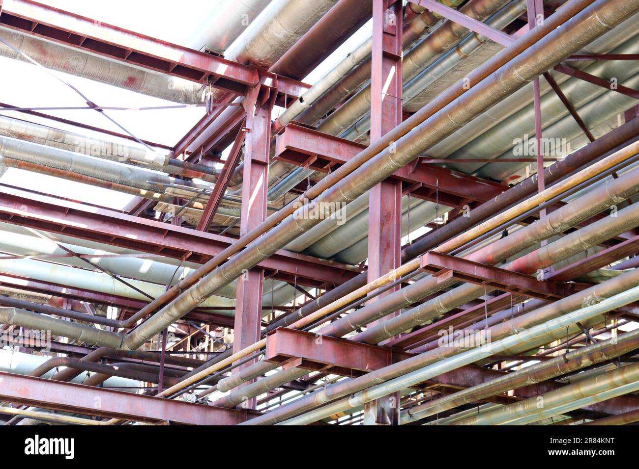The texture of a pipeline overpass with iron rusty pipes for pumping ...