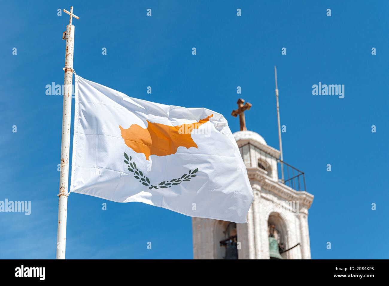 Flag of the Republic of Cyprus in front of church bell tower. Kolossi ...